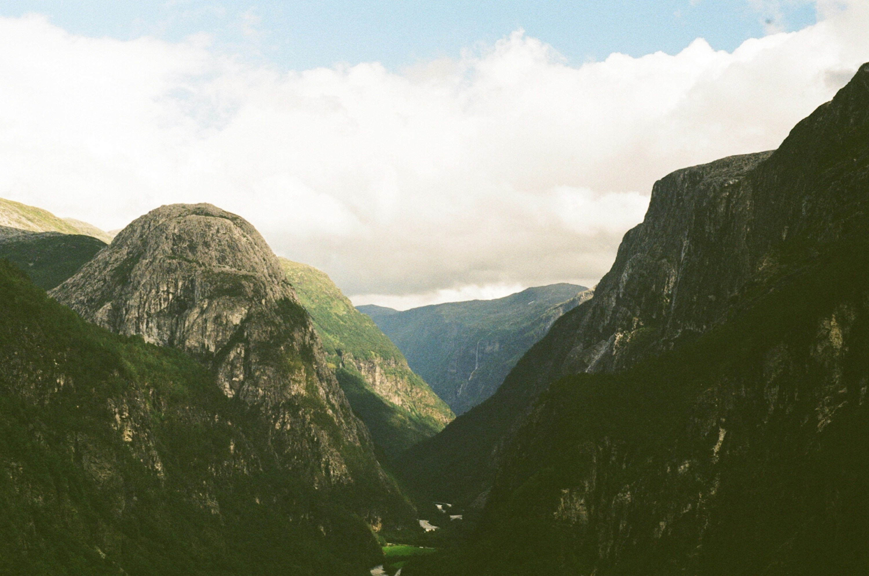 A view of a valley with mountains in the background photo – Free ...