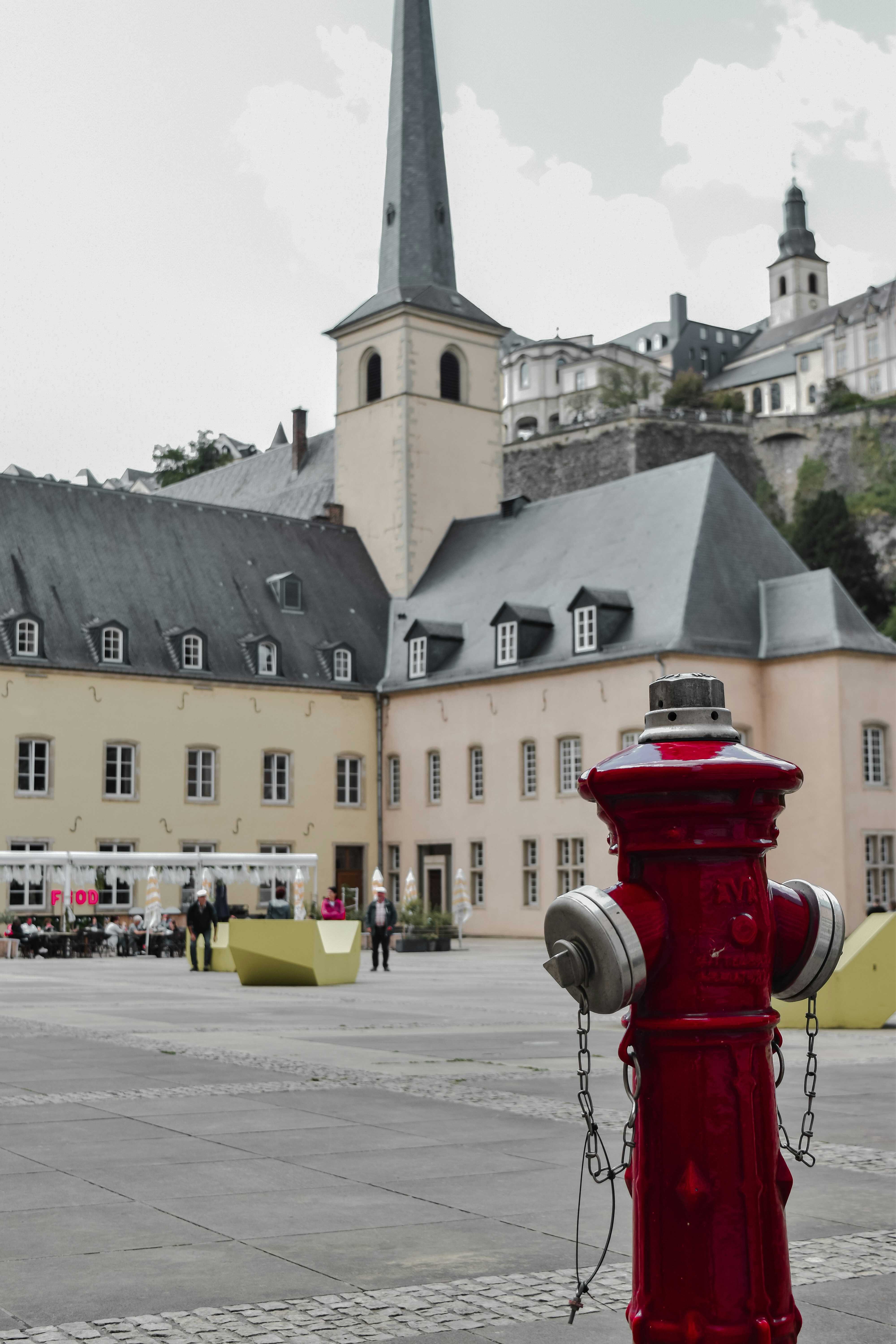 A red fire hydrant in front of a large building photo – Free Luxemburg ...