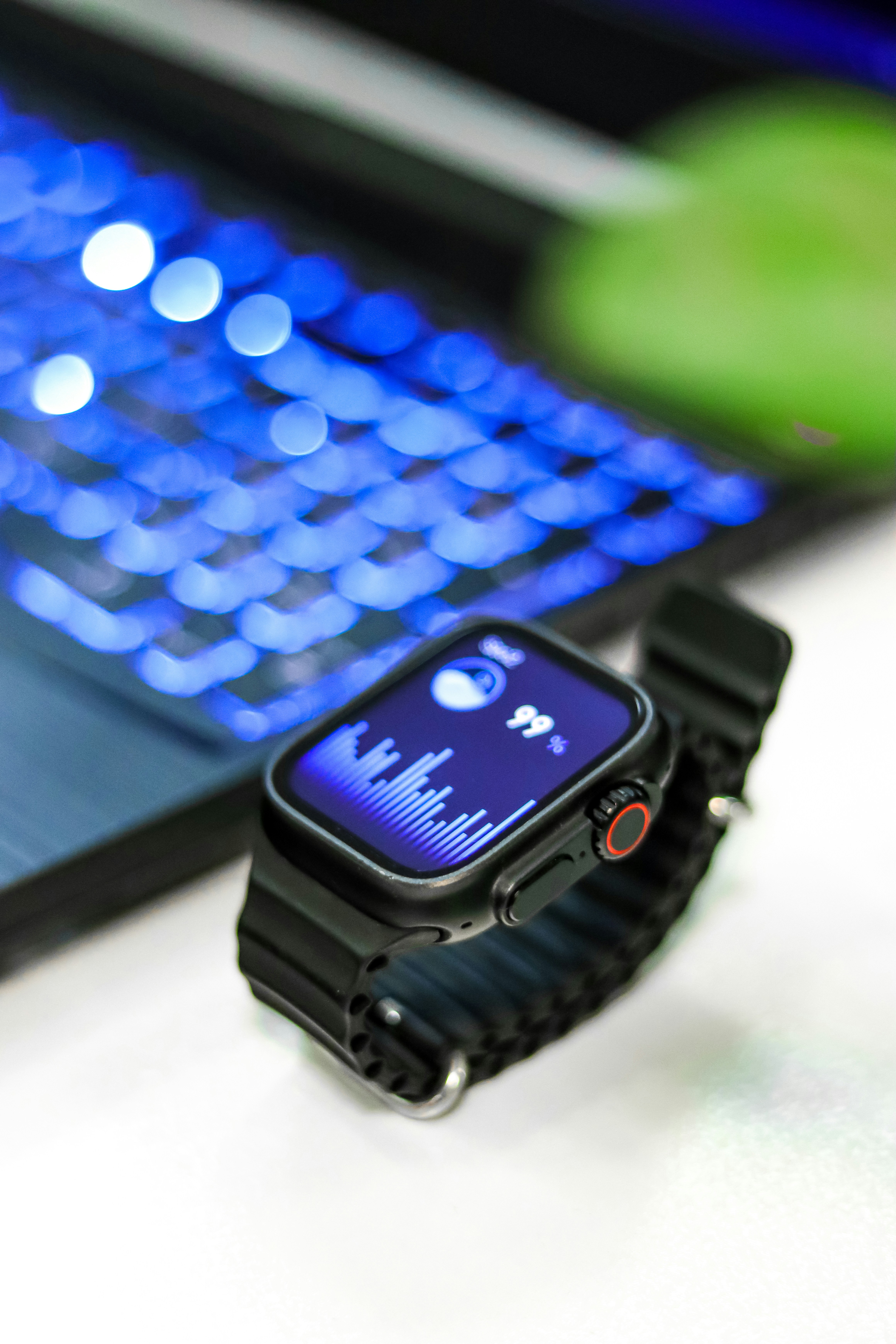 A smartwatch rests near a glowing laptop. photo – Free Watch Image on ...