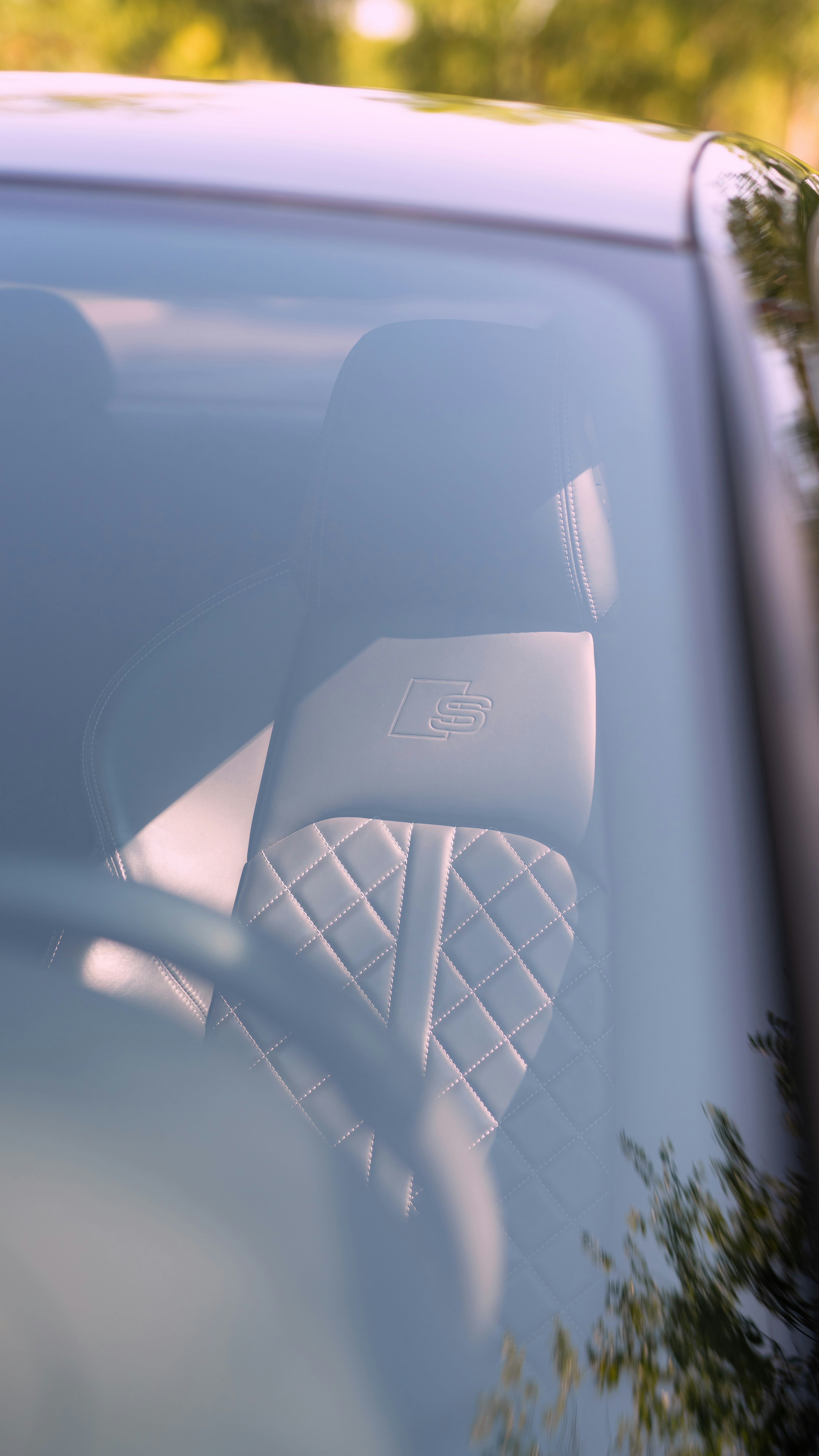 A close up of a car's dashboard with trees in the background photo ...