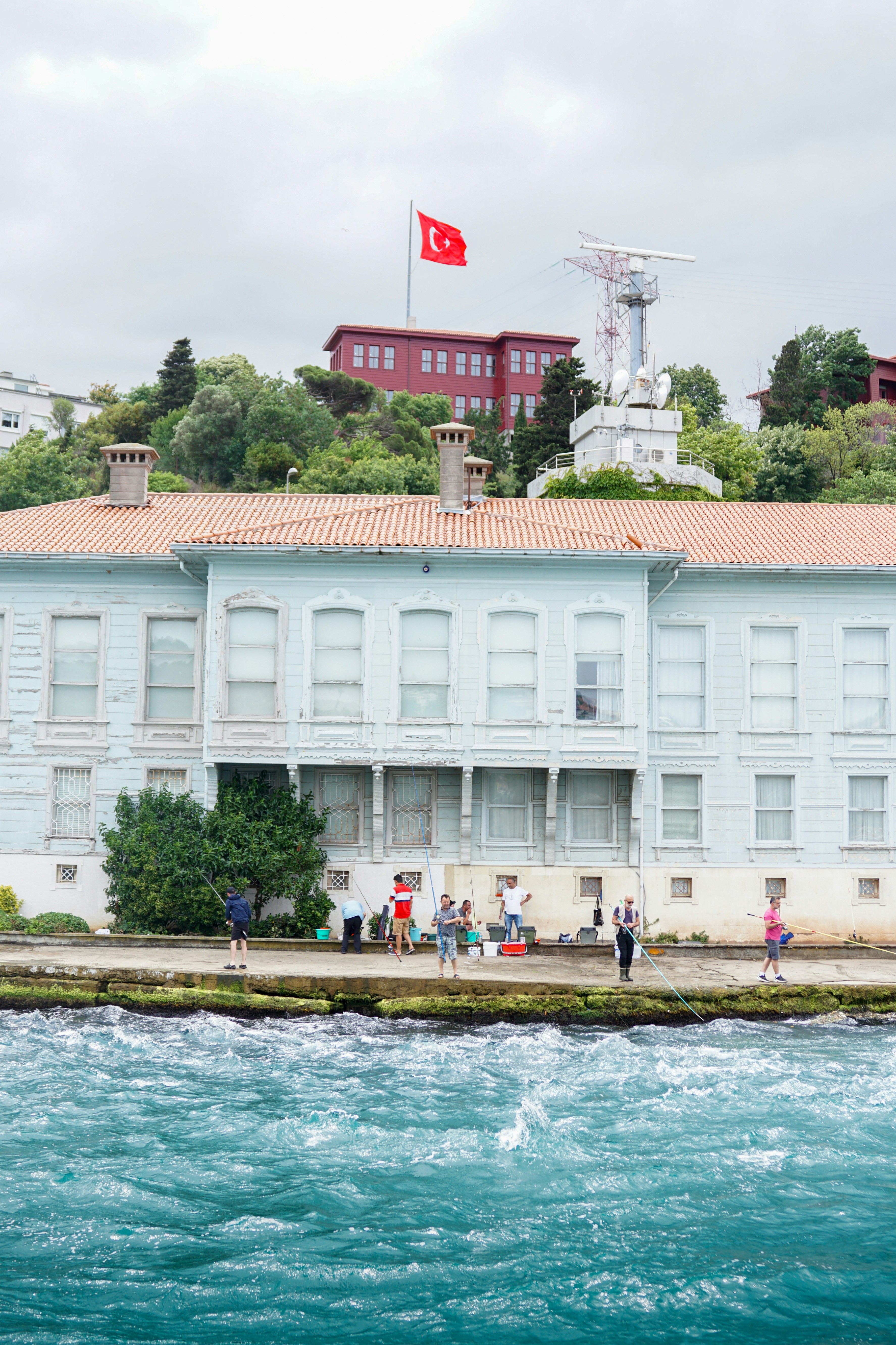 Turkish Flag Over a Serene Waterfront Facade