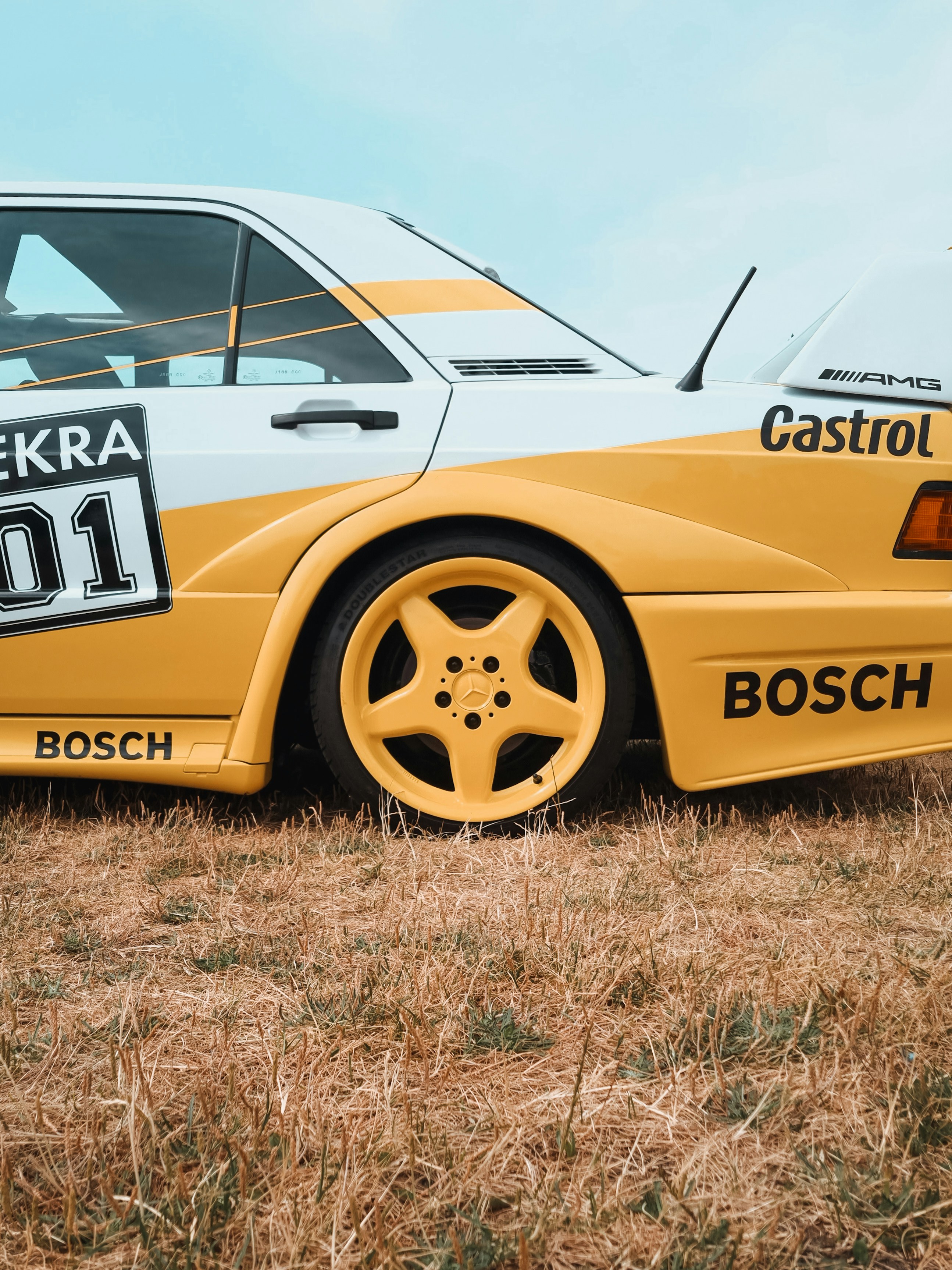 Sun-Kissed Sprint: Retro Racing Car on a Dry Grass Field