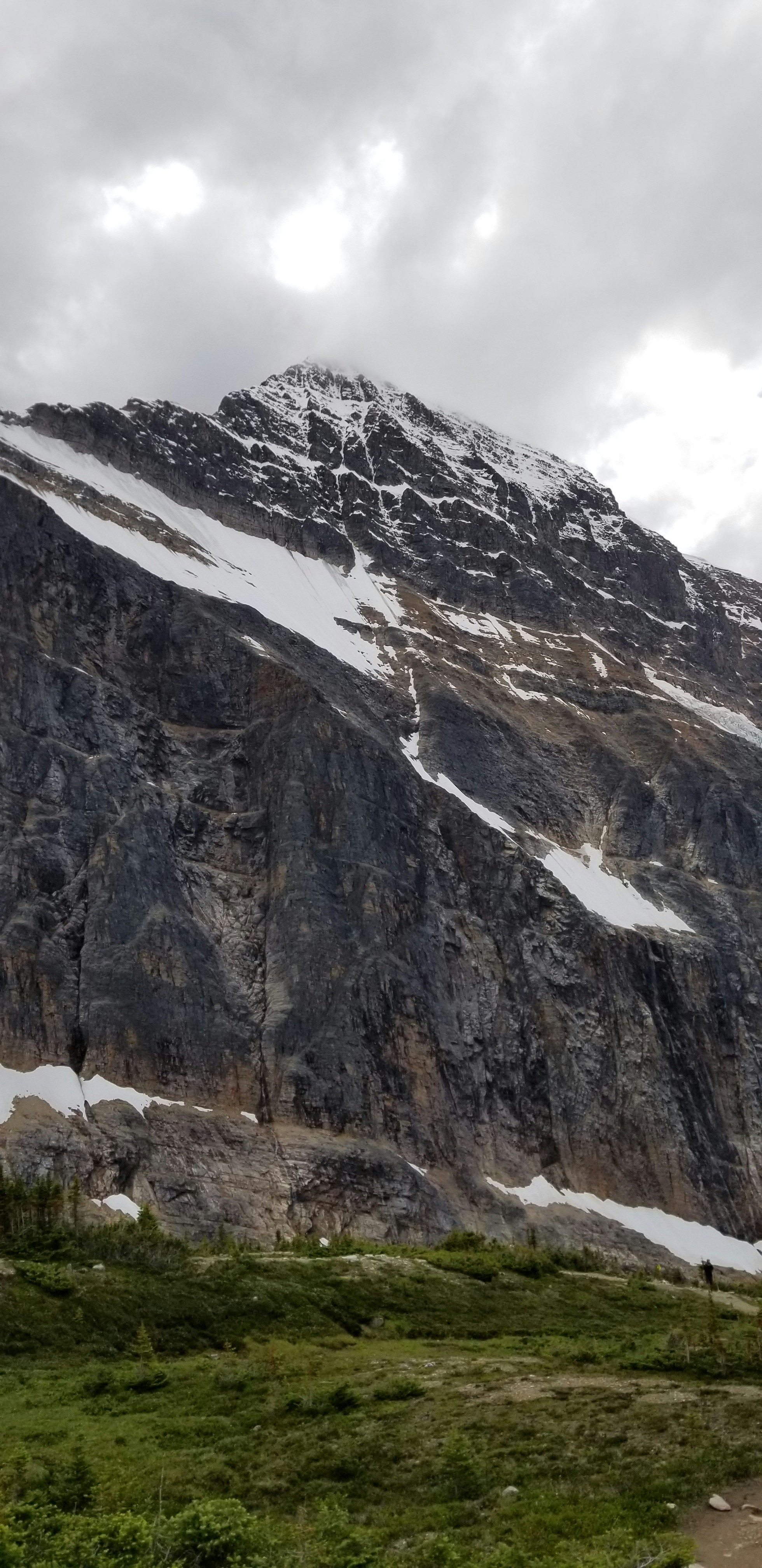 Snow-veined Granite Summit under a Moody Alpine Sky