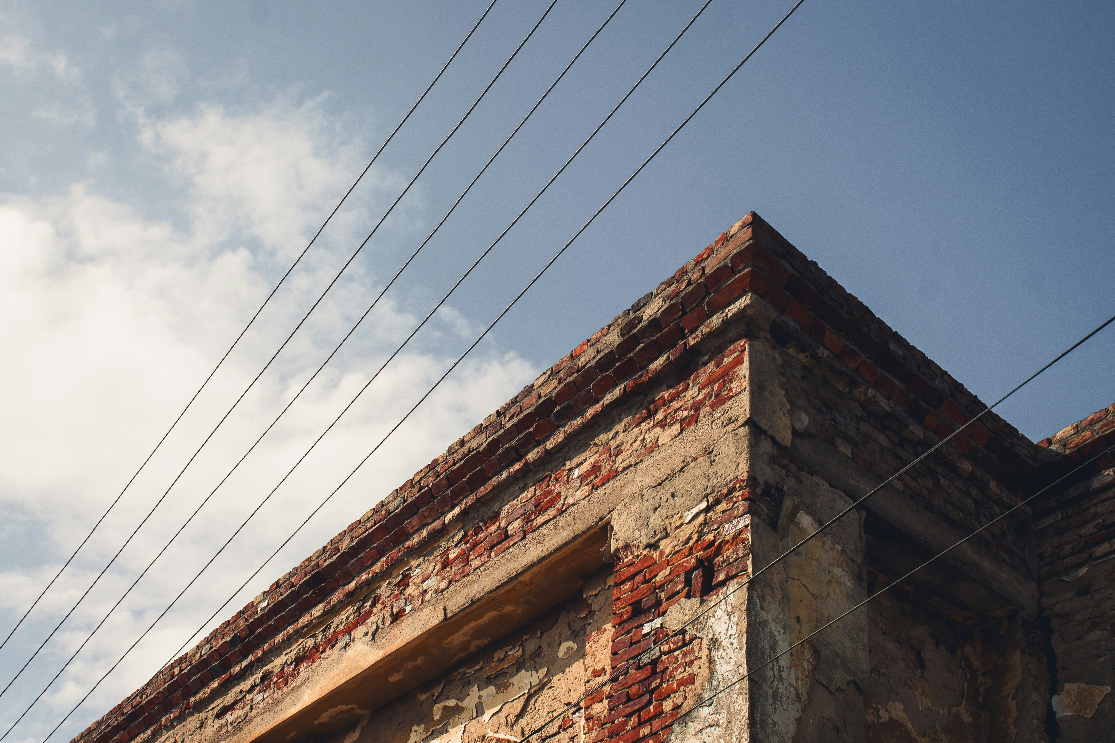 A brick building with power lines above it photo – Free Budapest Image ...