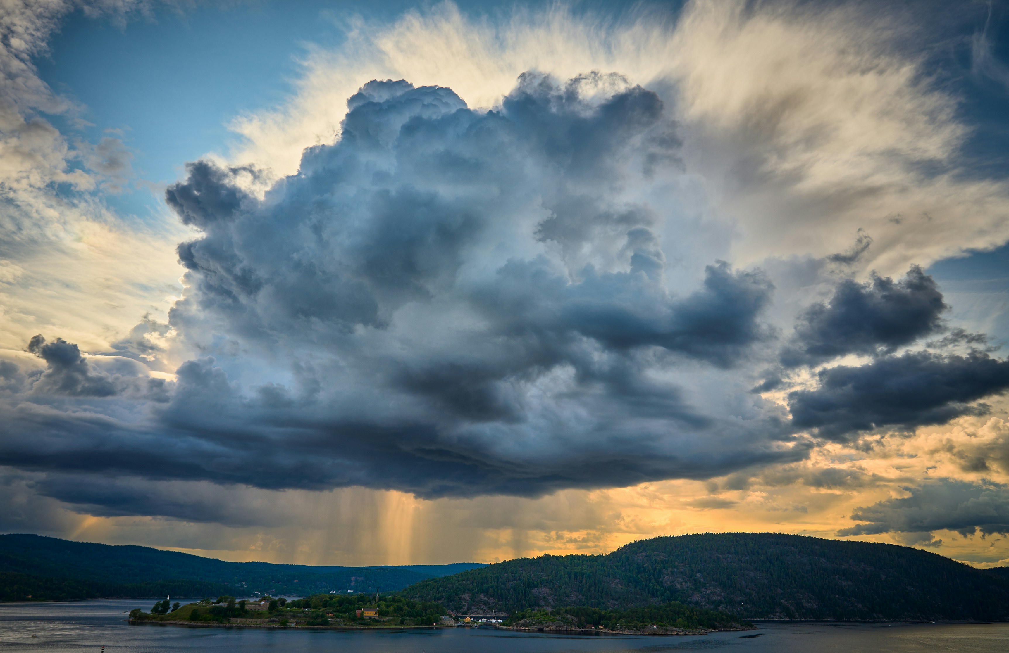 a cloudy sky over a body of water