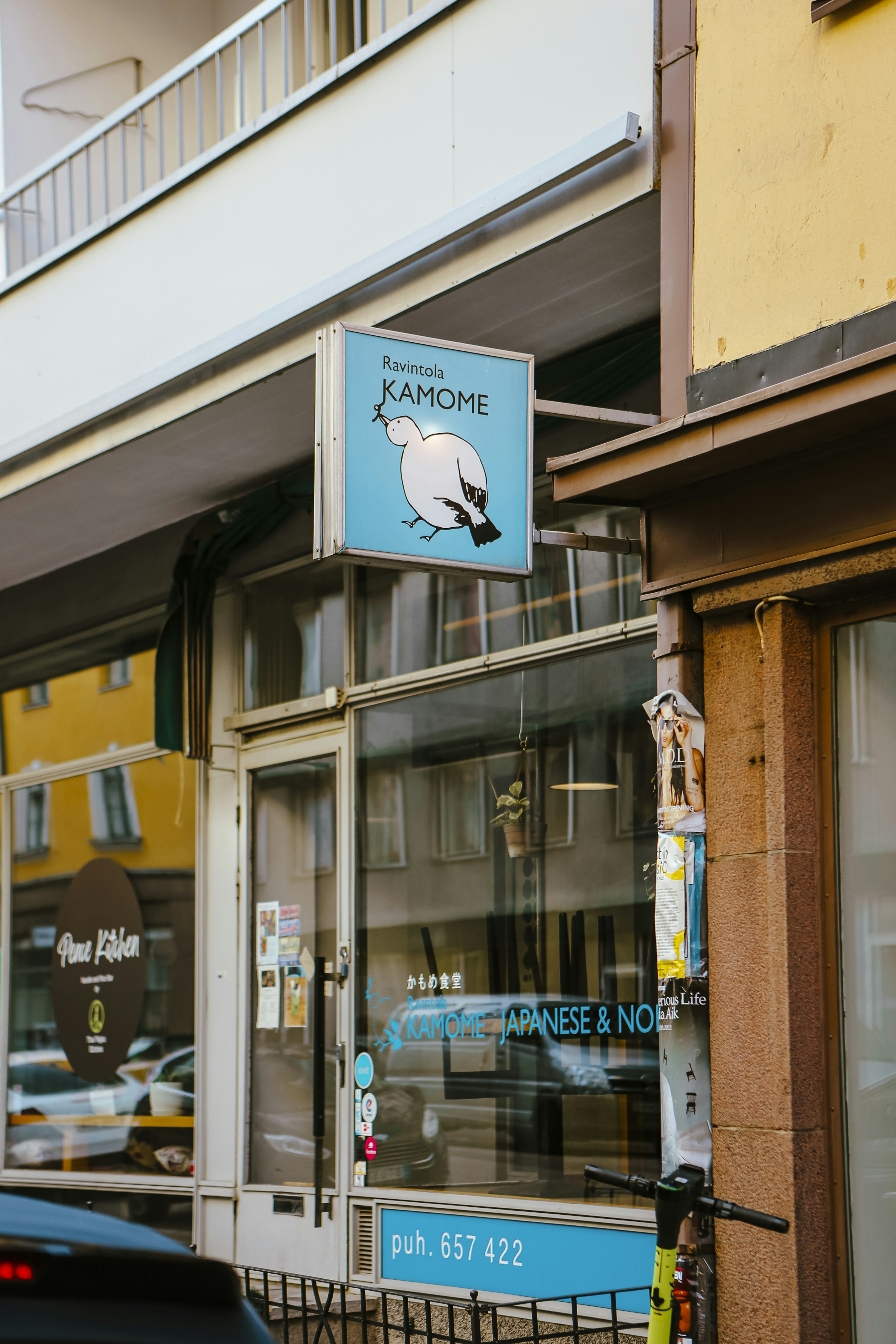 A store front with a blue sign hanging from the side of it photo – Free ...