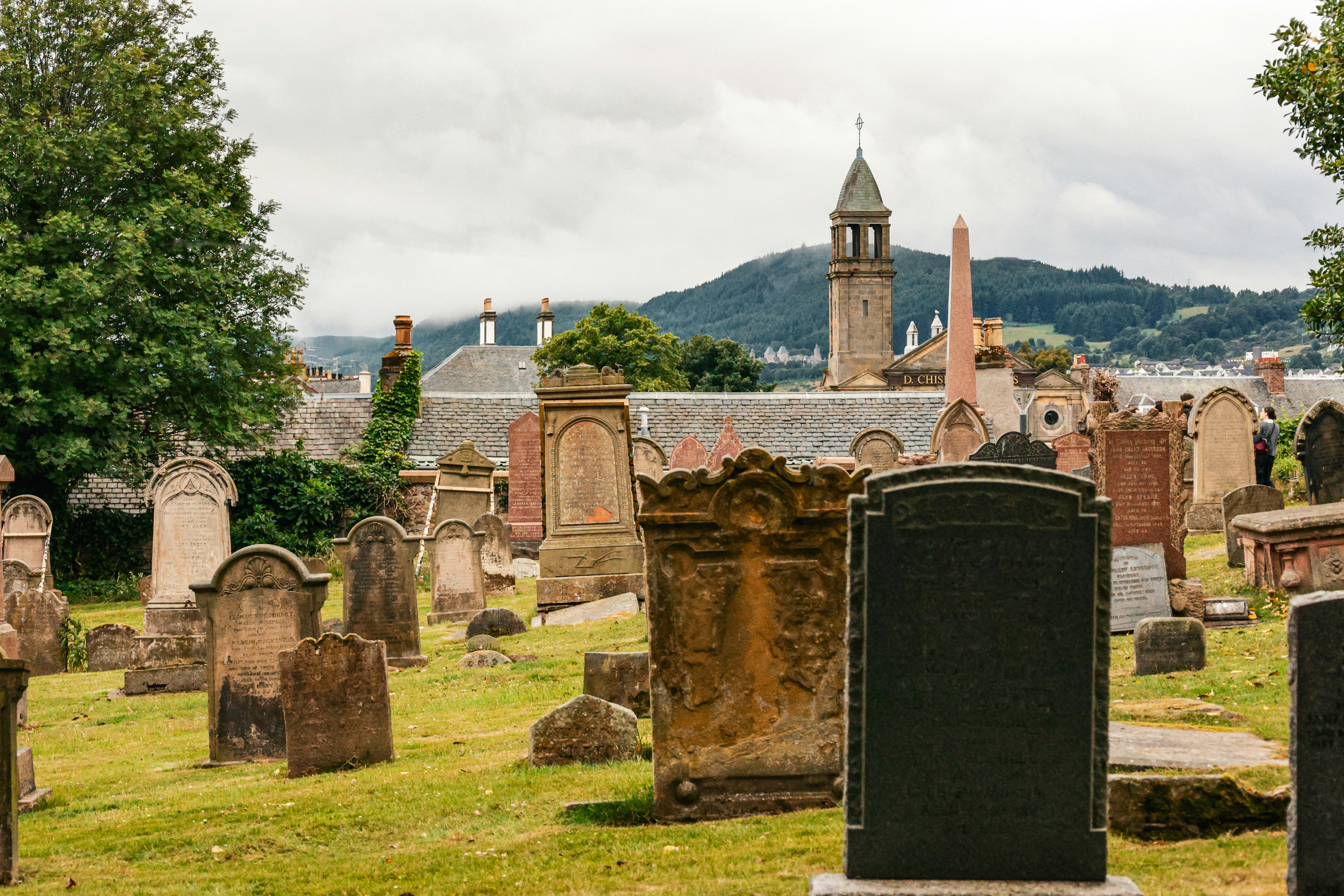 A cemetery with a clock tower in the background photo – Free Outdoors ...