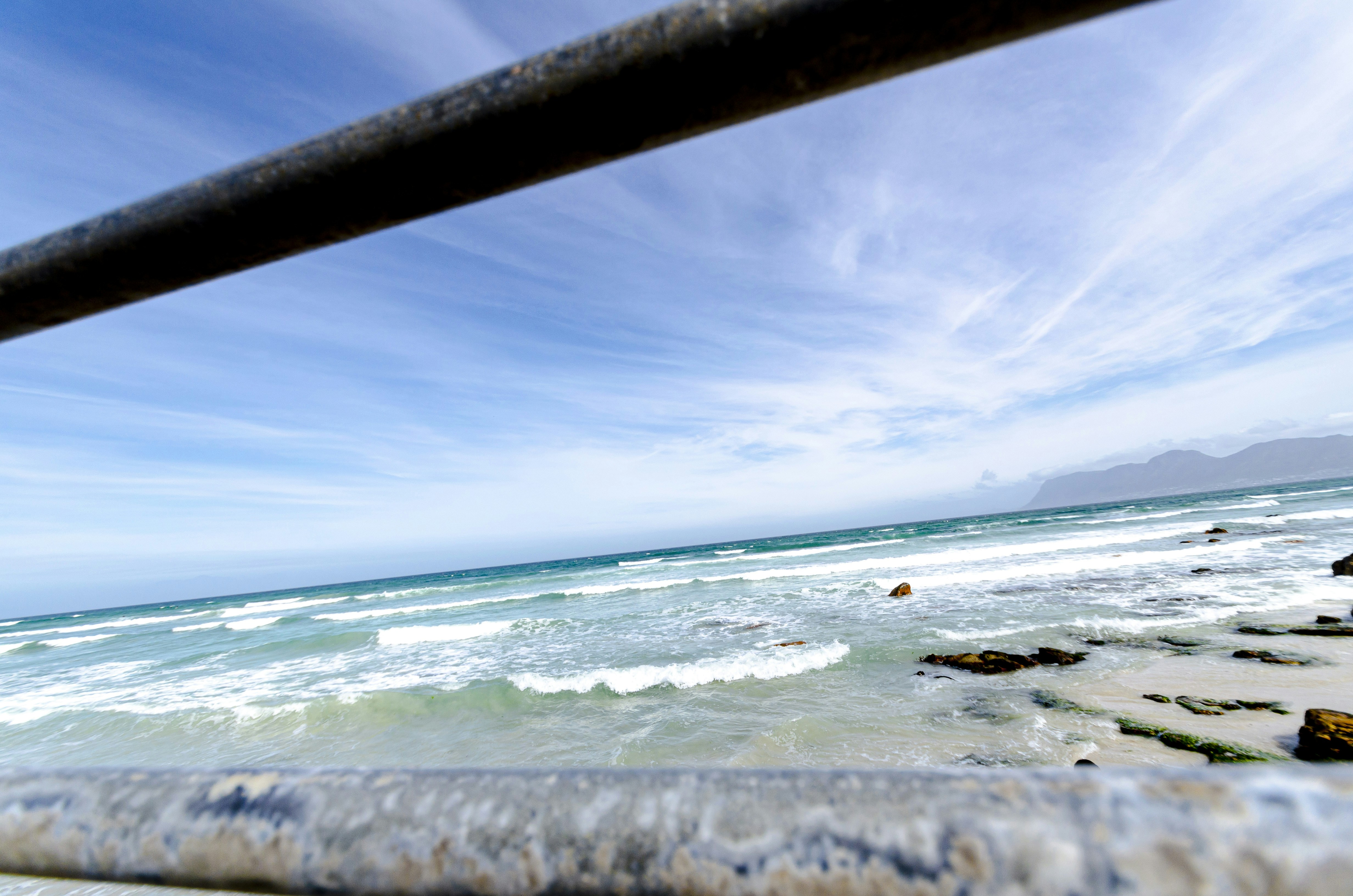 Rusted Rails Framing a Seaside Horizon