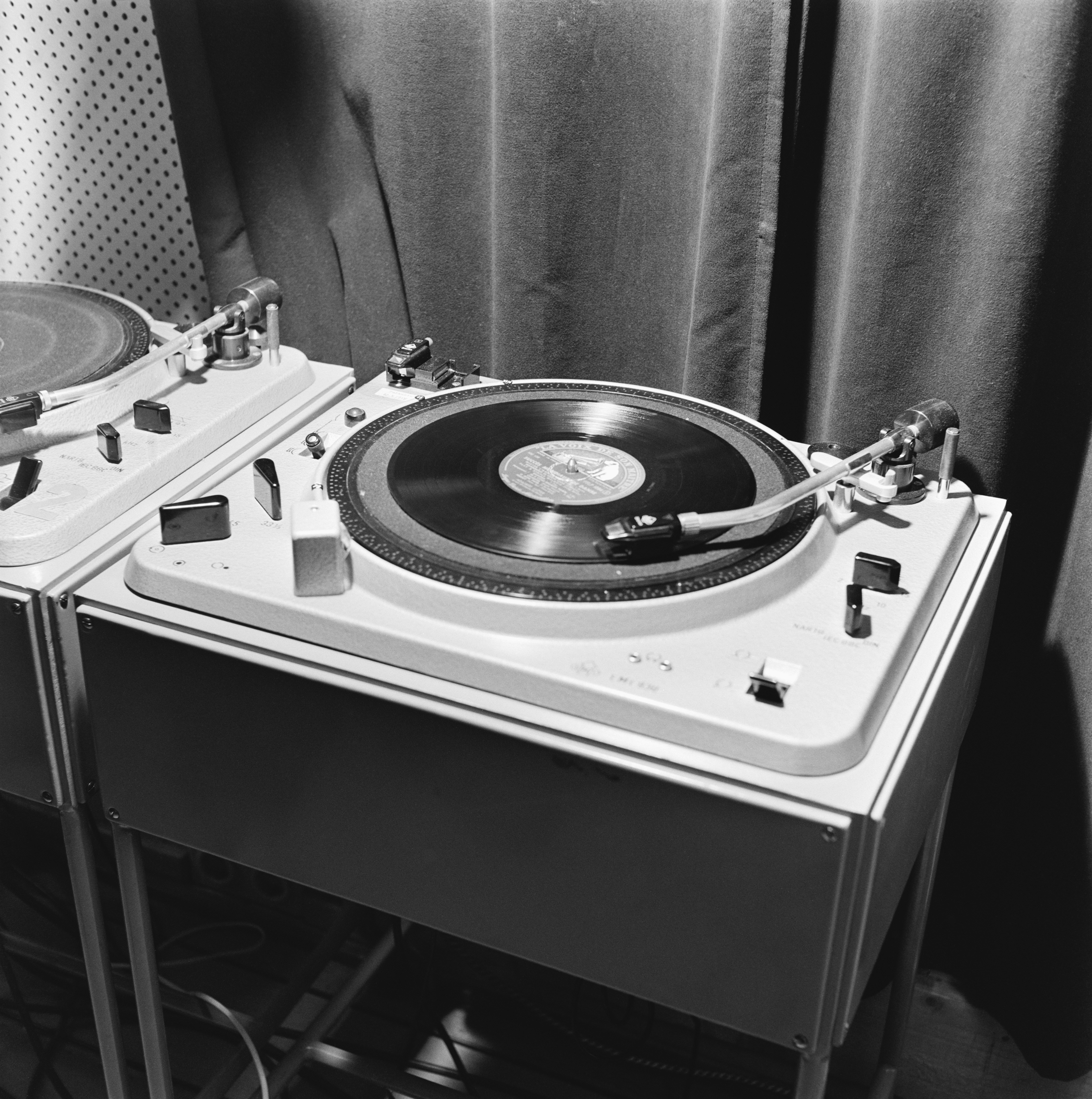 A turntable sitting on top of a table next to a curtain photo – Free ...