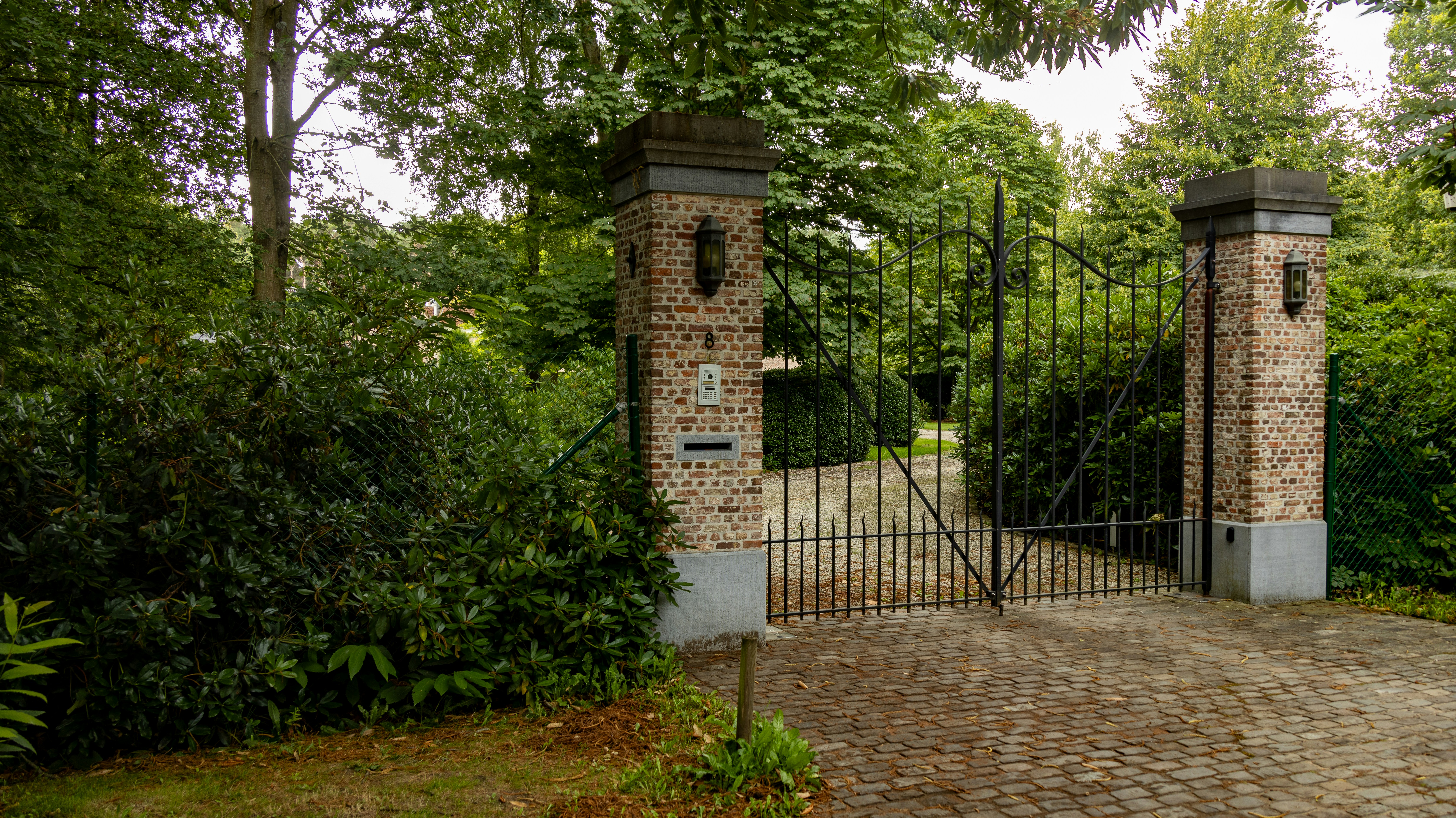 A brick gate with two gates and a brick walkway photo – Free House ...
