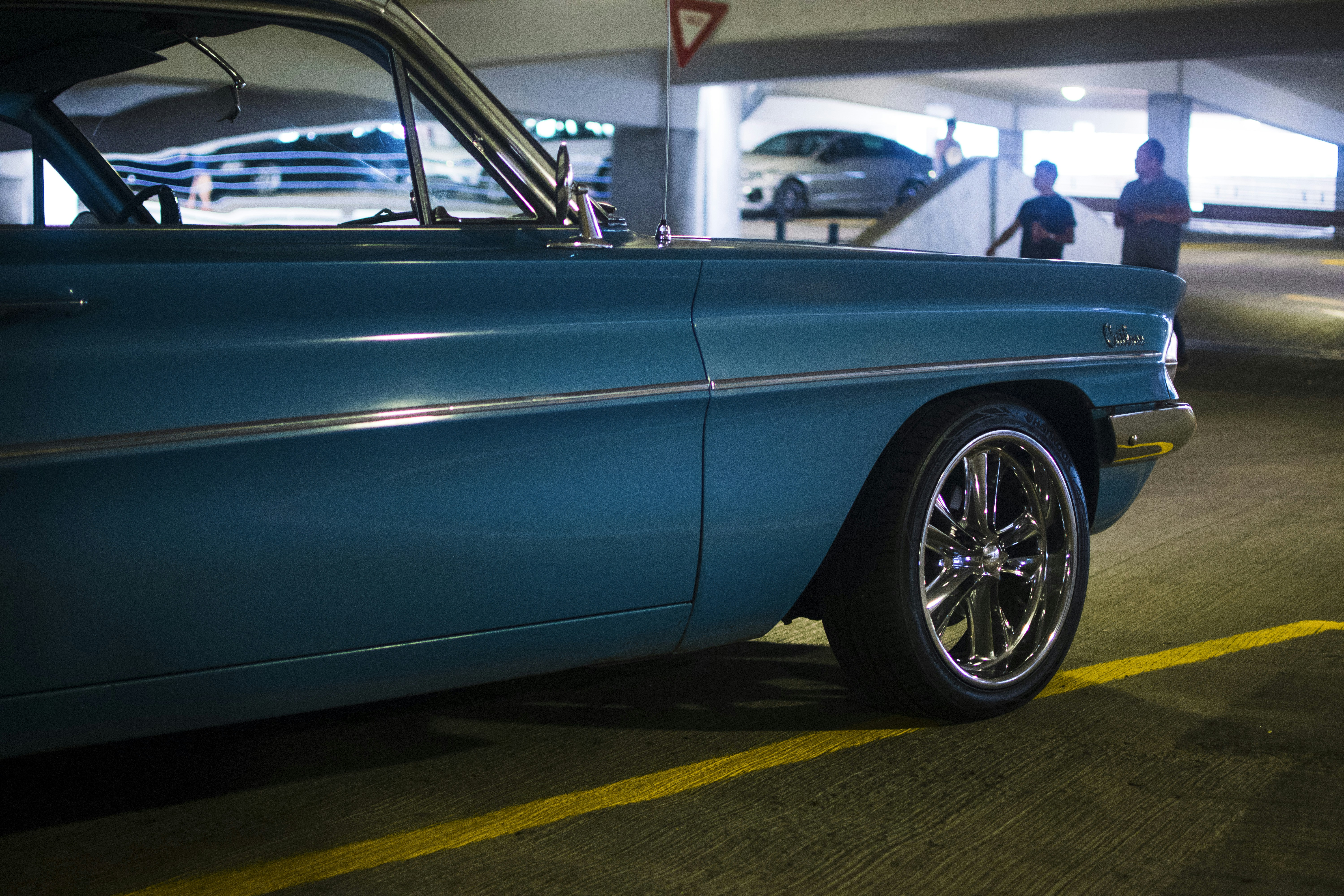 A blue car parked in a parking garage photo – Free Leamington ramp ...