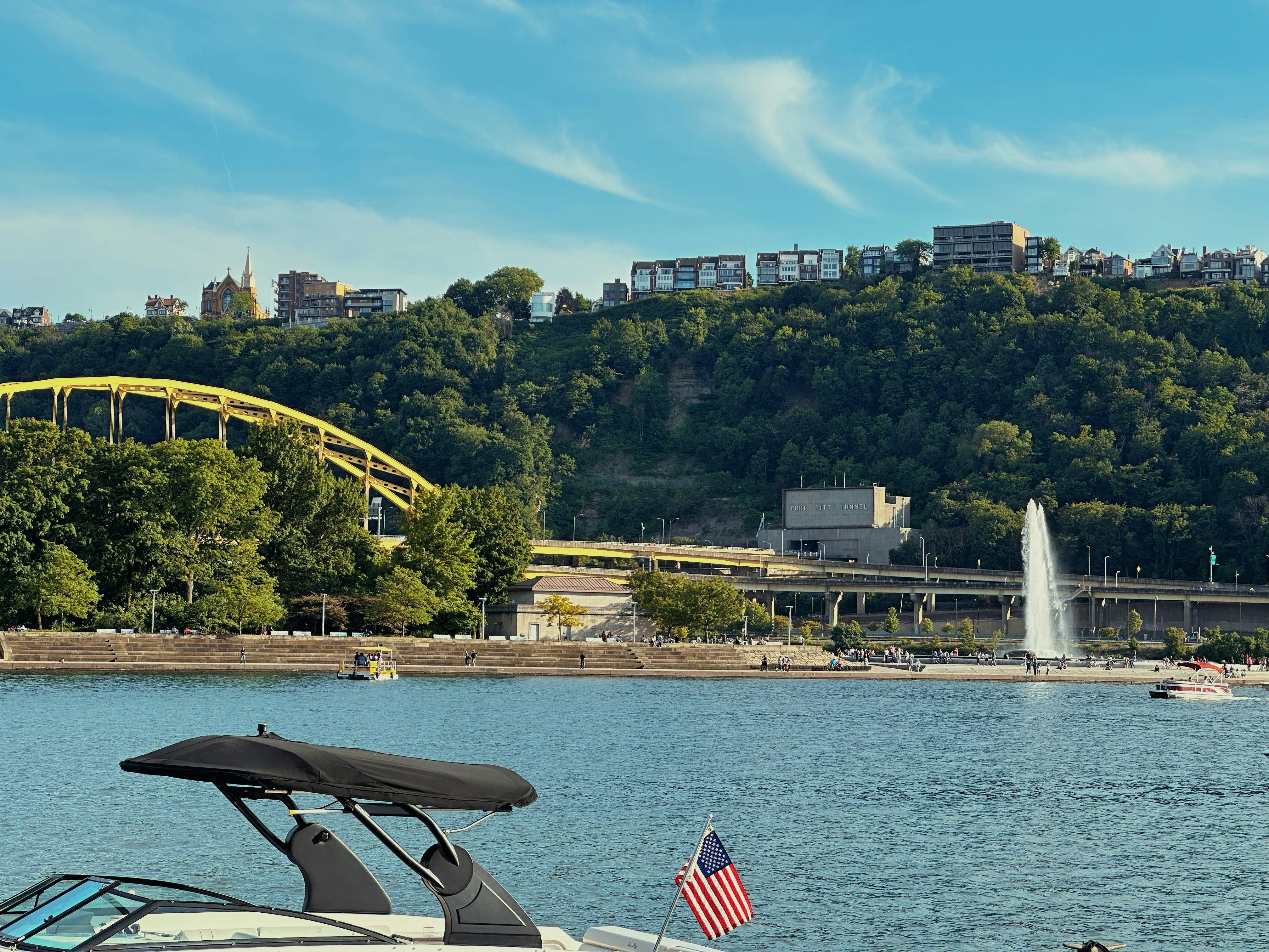 A boat in the water with a city in the background photo – Free ...