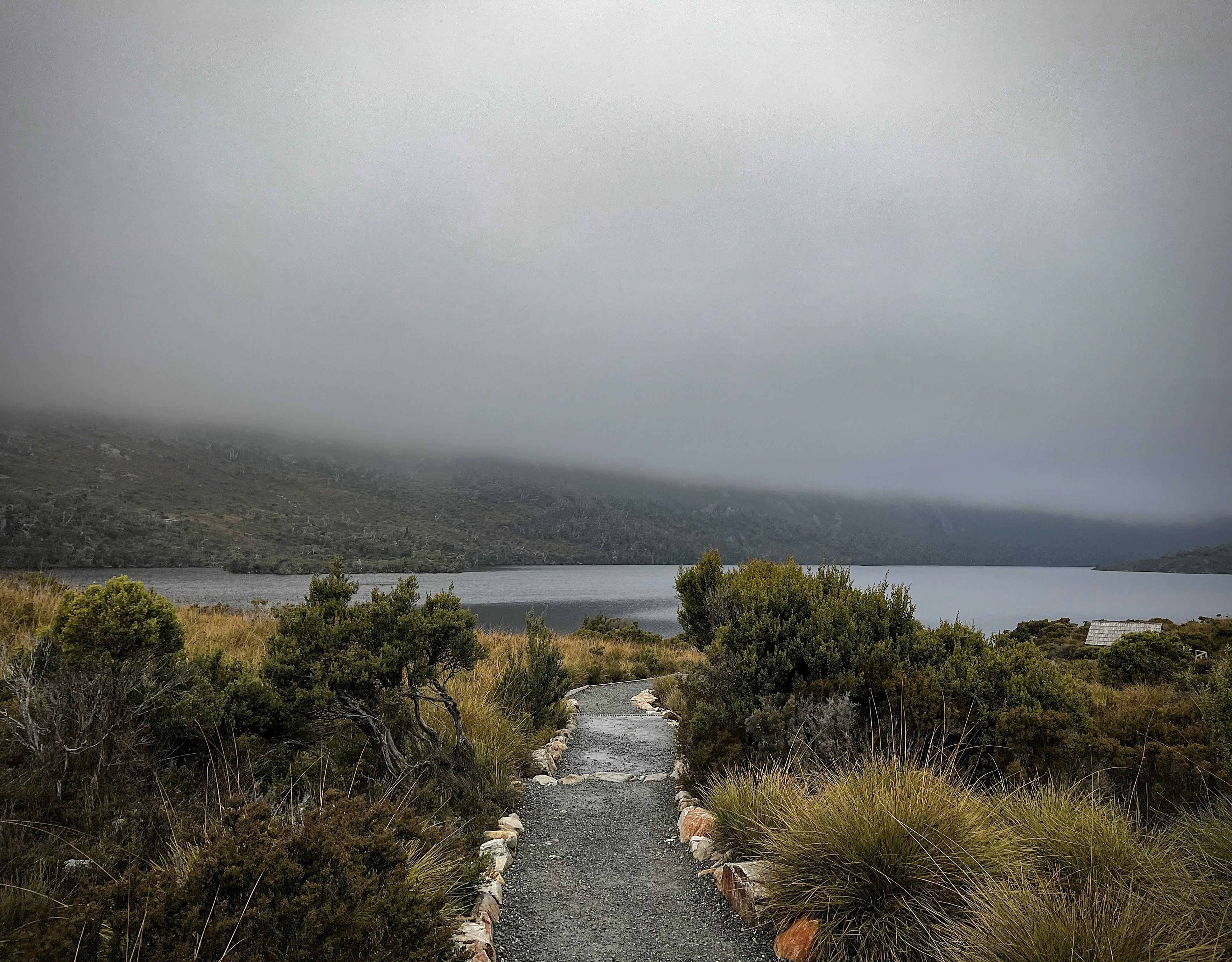 A path leading to a body of water on a cloudy day photo – Free ...