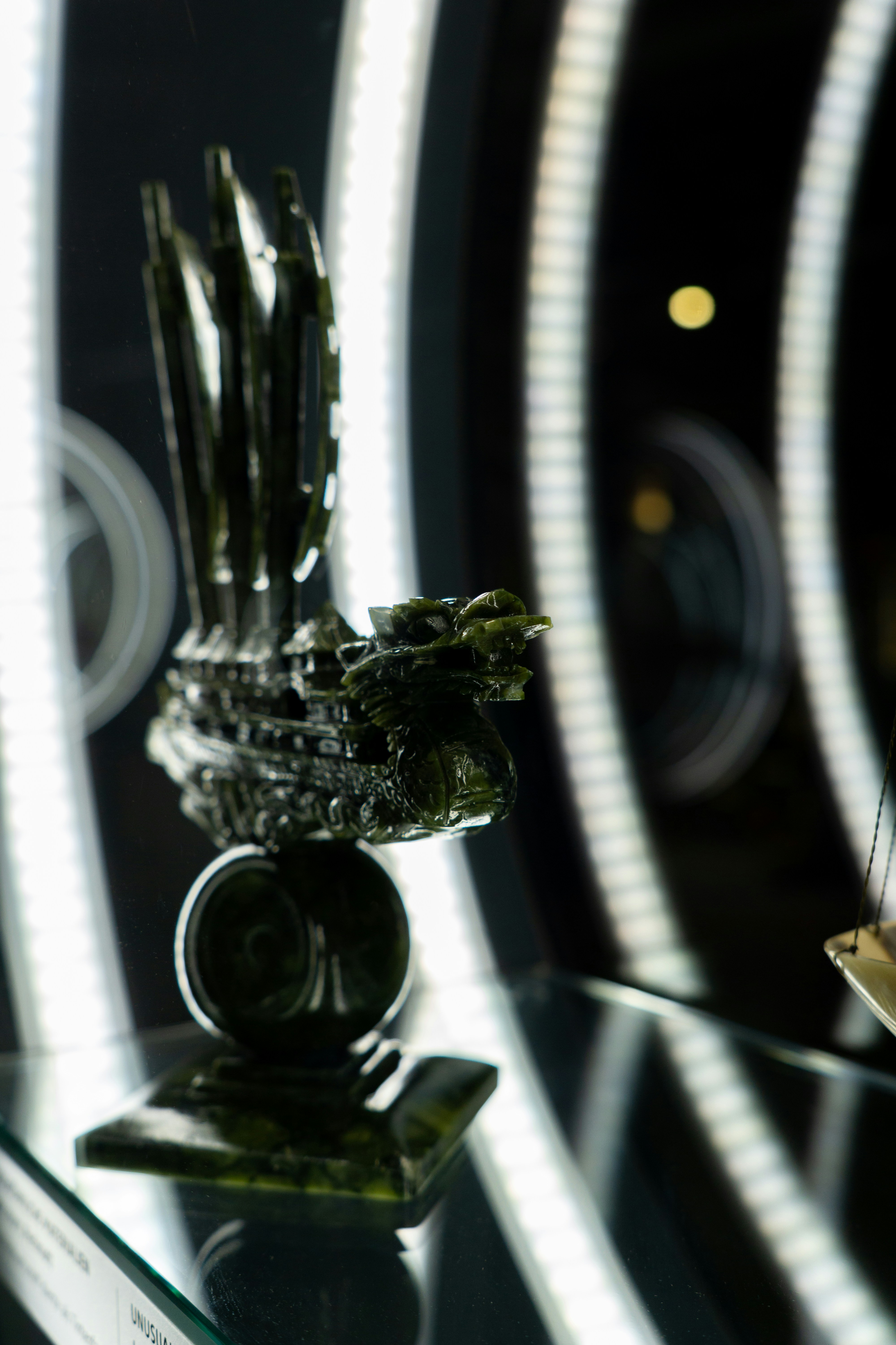 Emerald Dragon in a Ring-Lit Glass Showcase