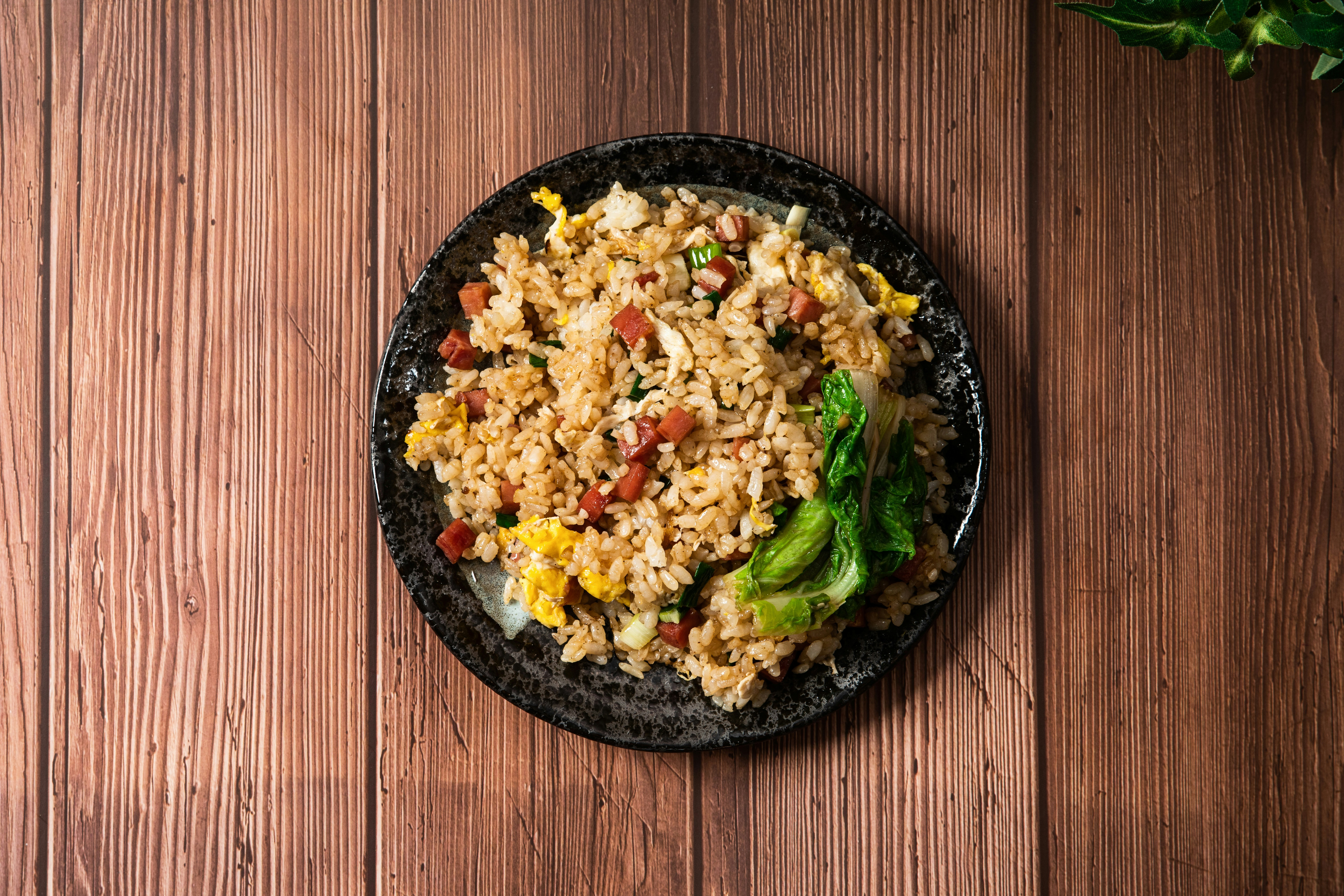 A plate of rice and vegetables on a wooden table photo – Free Food ...