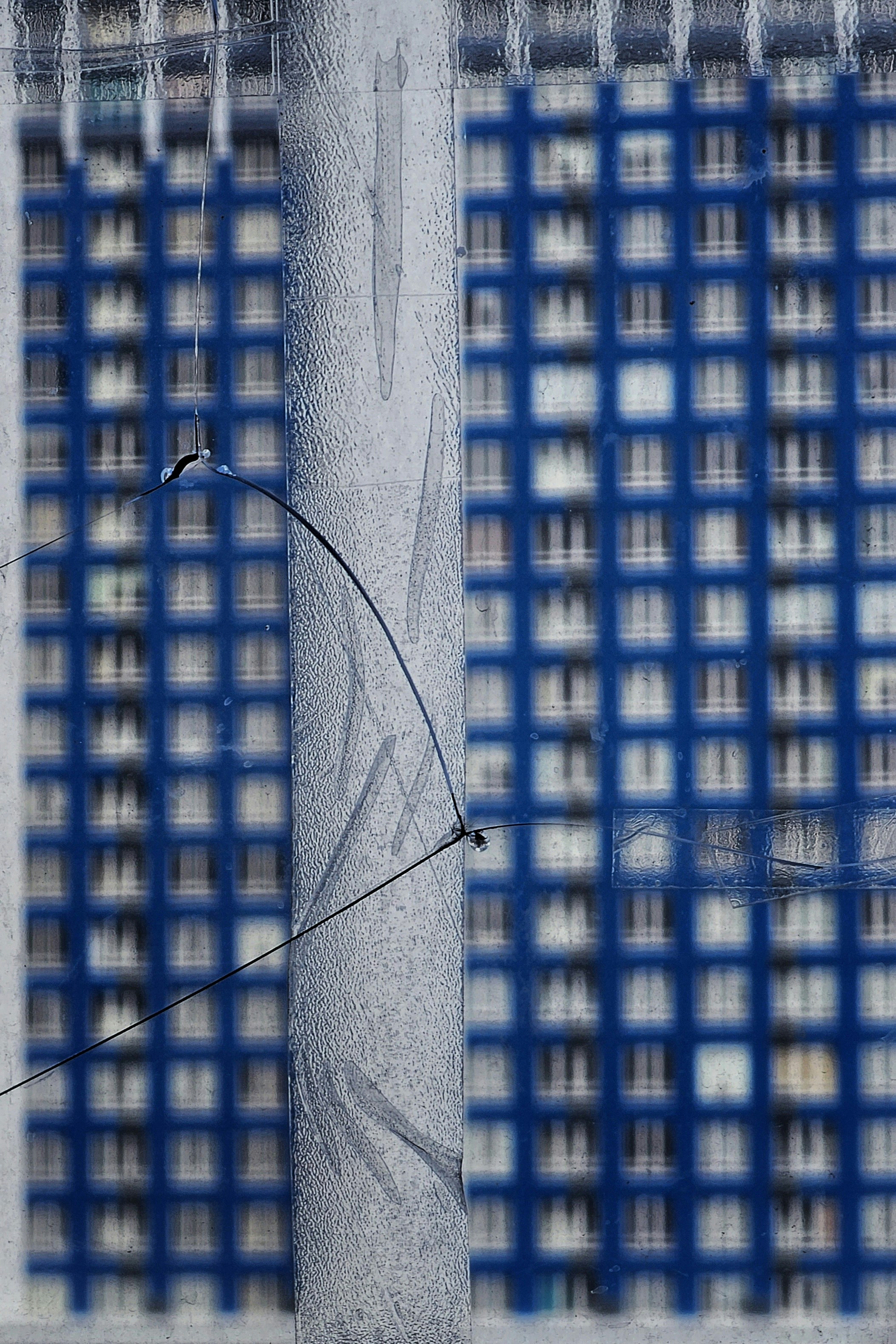 Pole and Wires Amid Indigo Gridwork