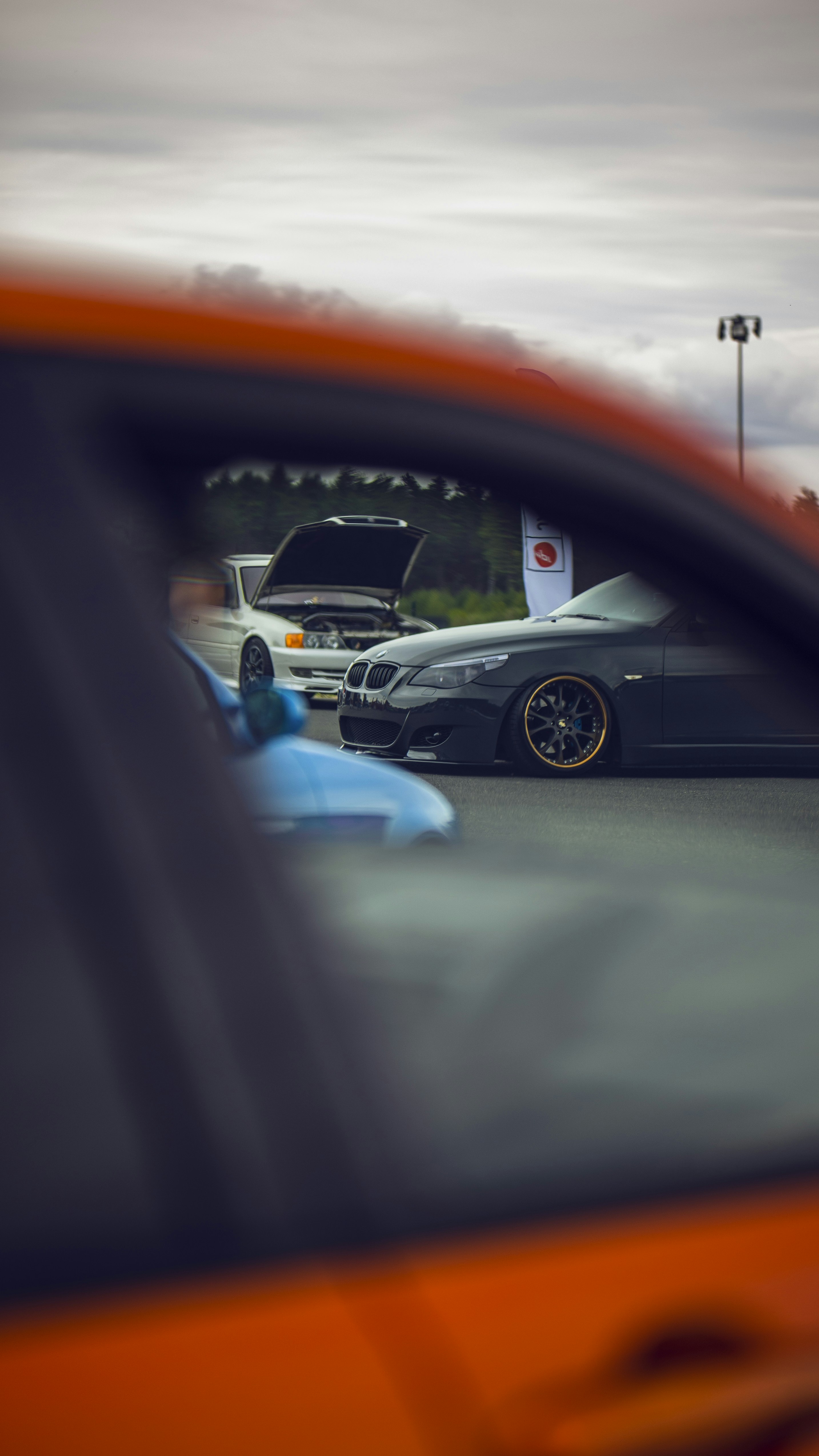 Through the Curve: A Car Show Reflection Framed by the Window