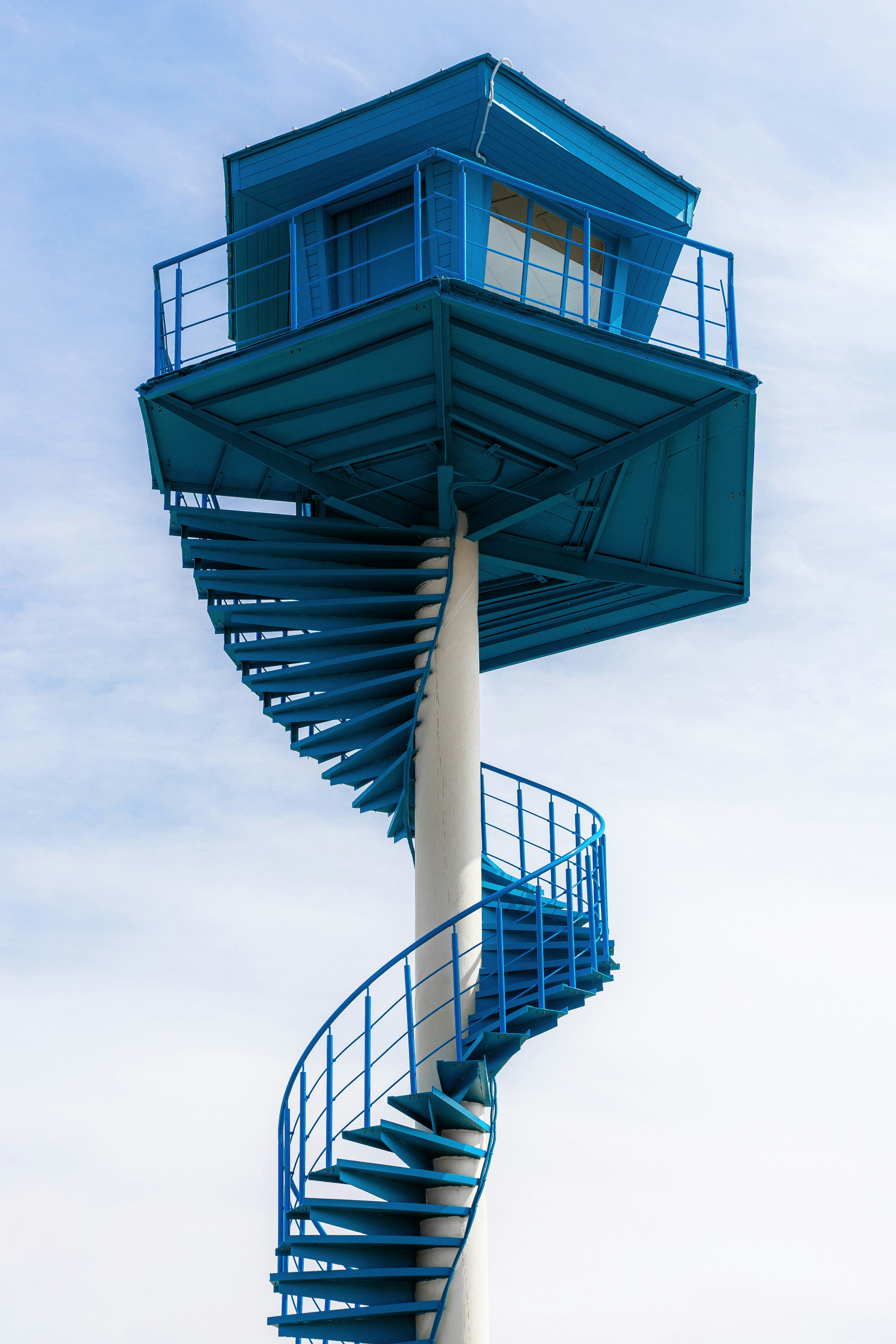 A tall blue tower with a spiral staircase photo – Free Building Image ...