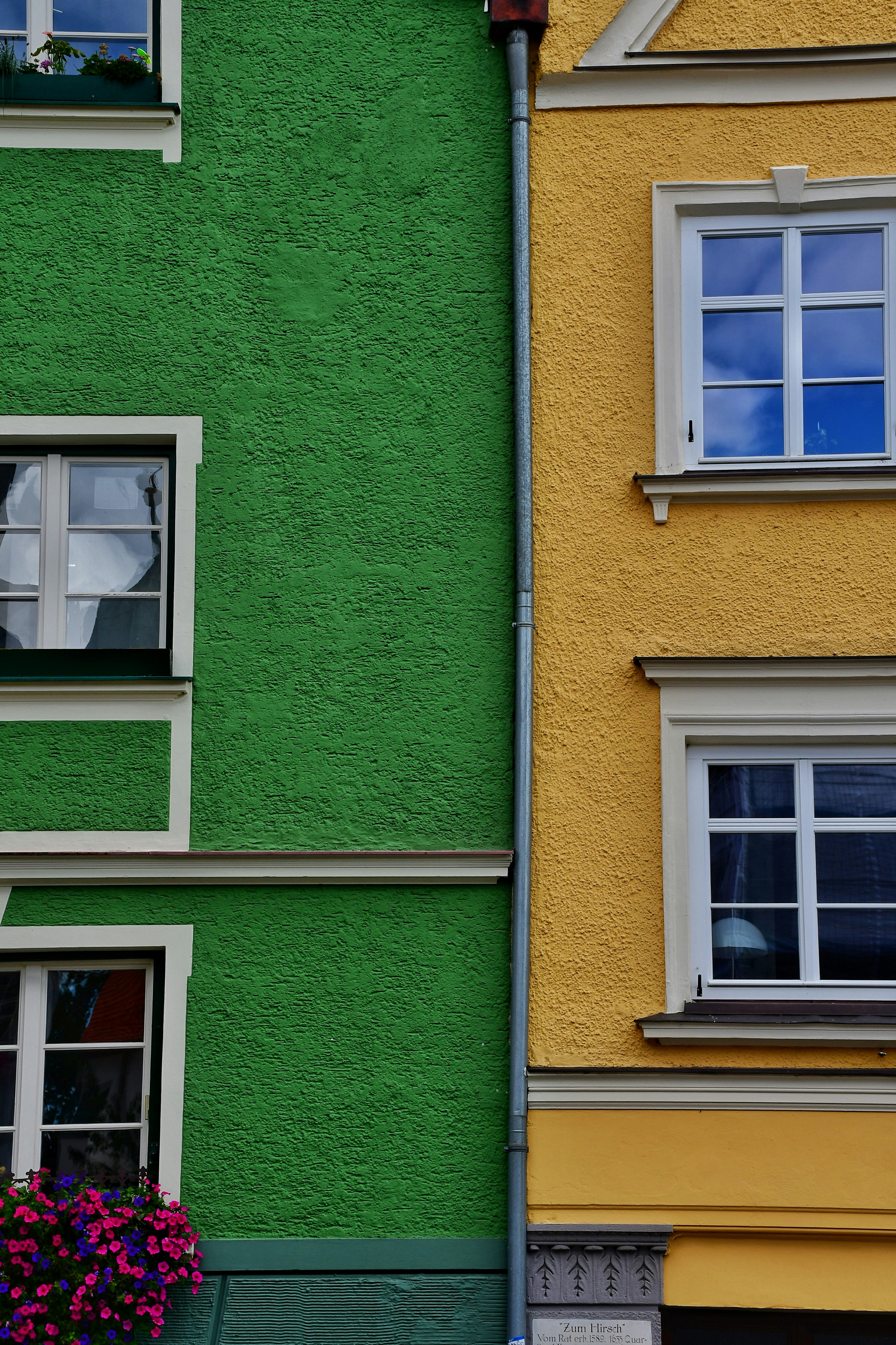 A green and yellow building next to a yellow and green building photo ...