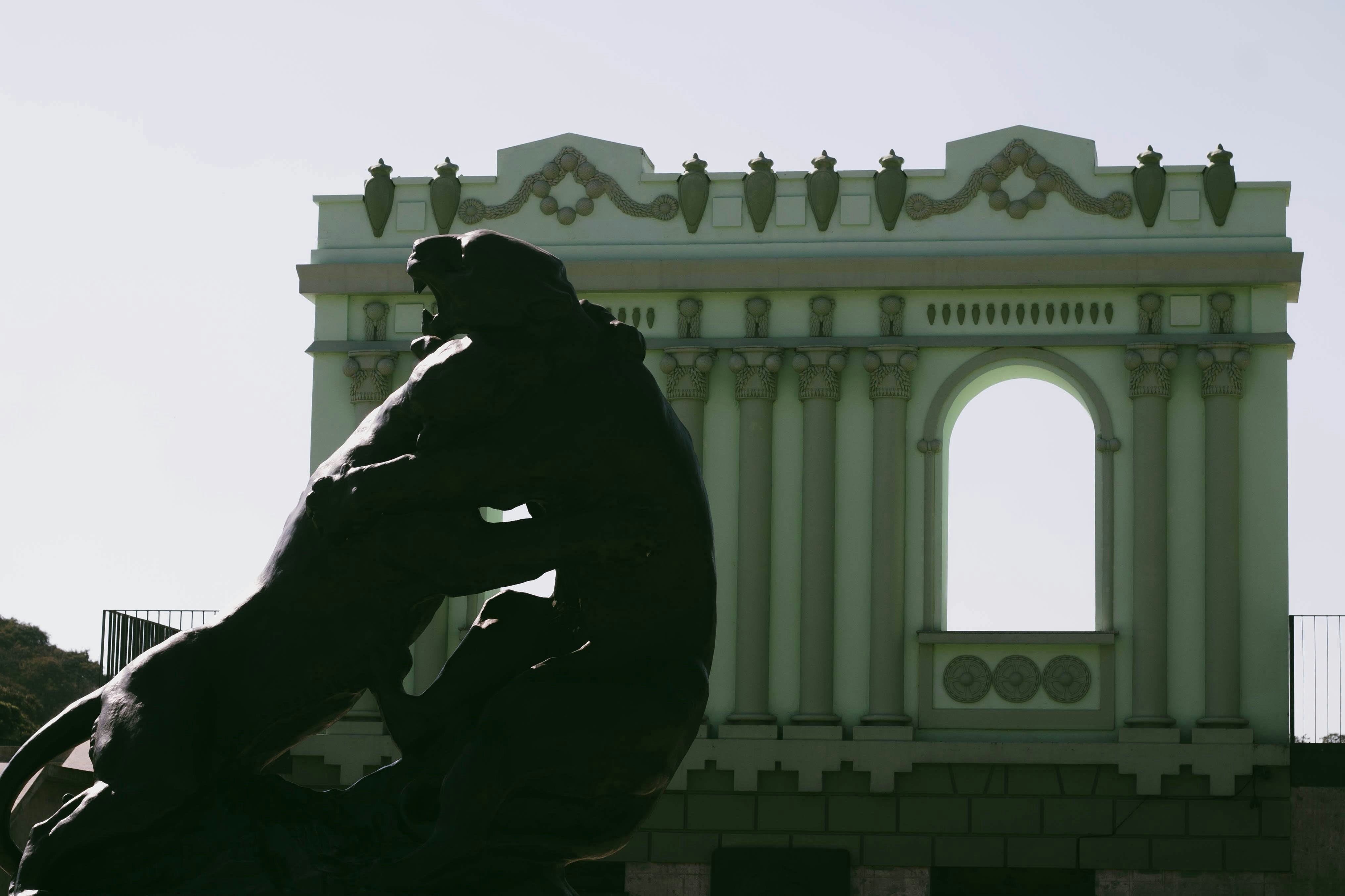 Bronze Discord: A Sculpted Duel Framing a Neoclassical Facade