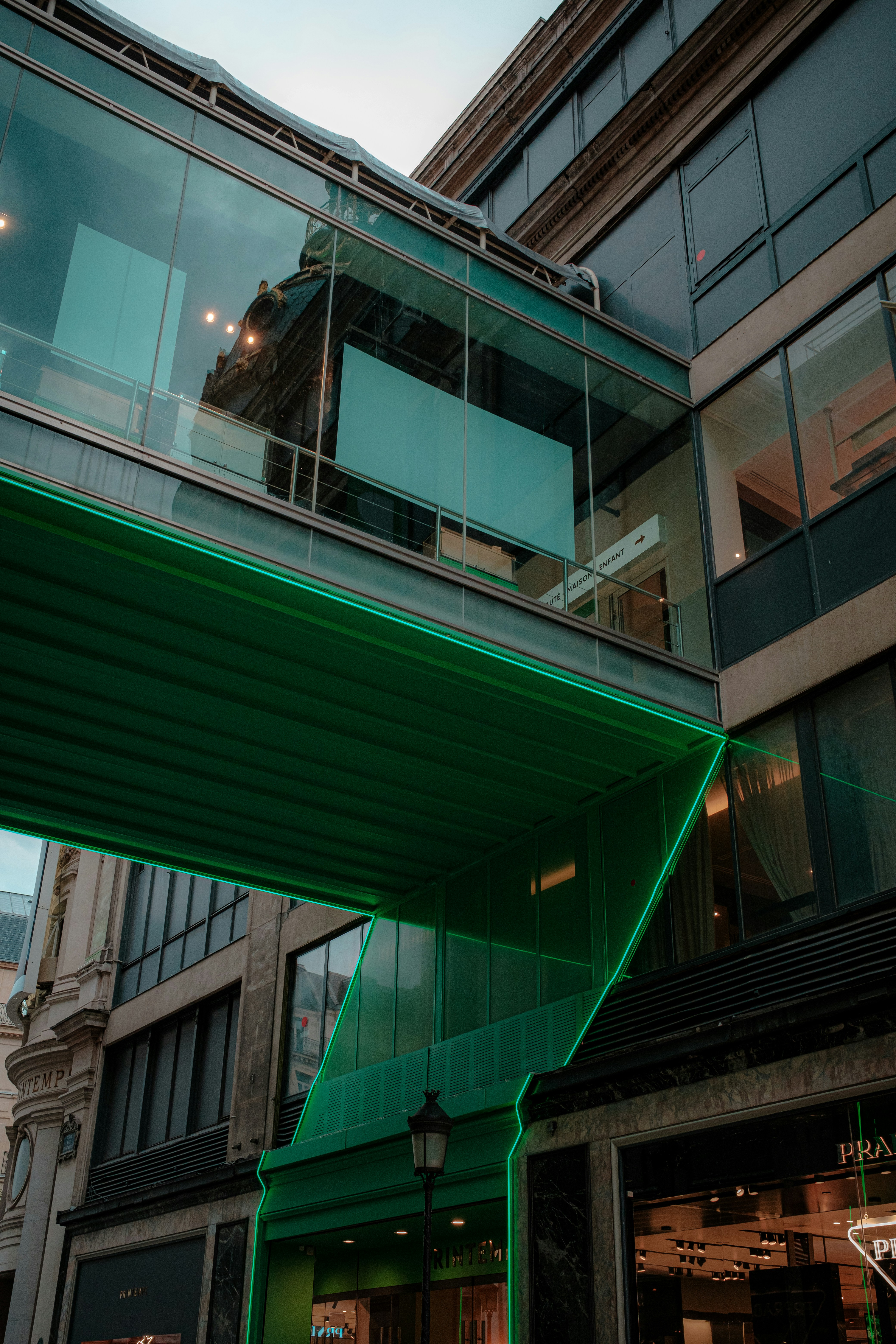 Emerald Neon Spine Framing a Glass-Fronted Block