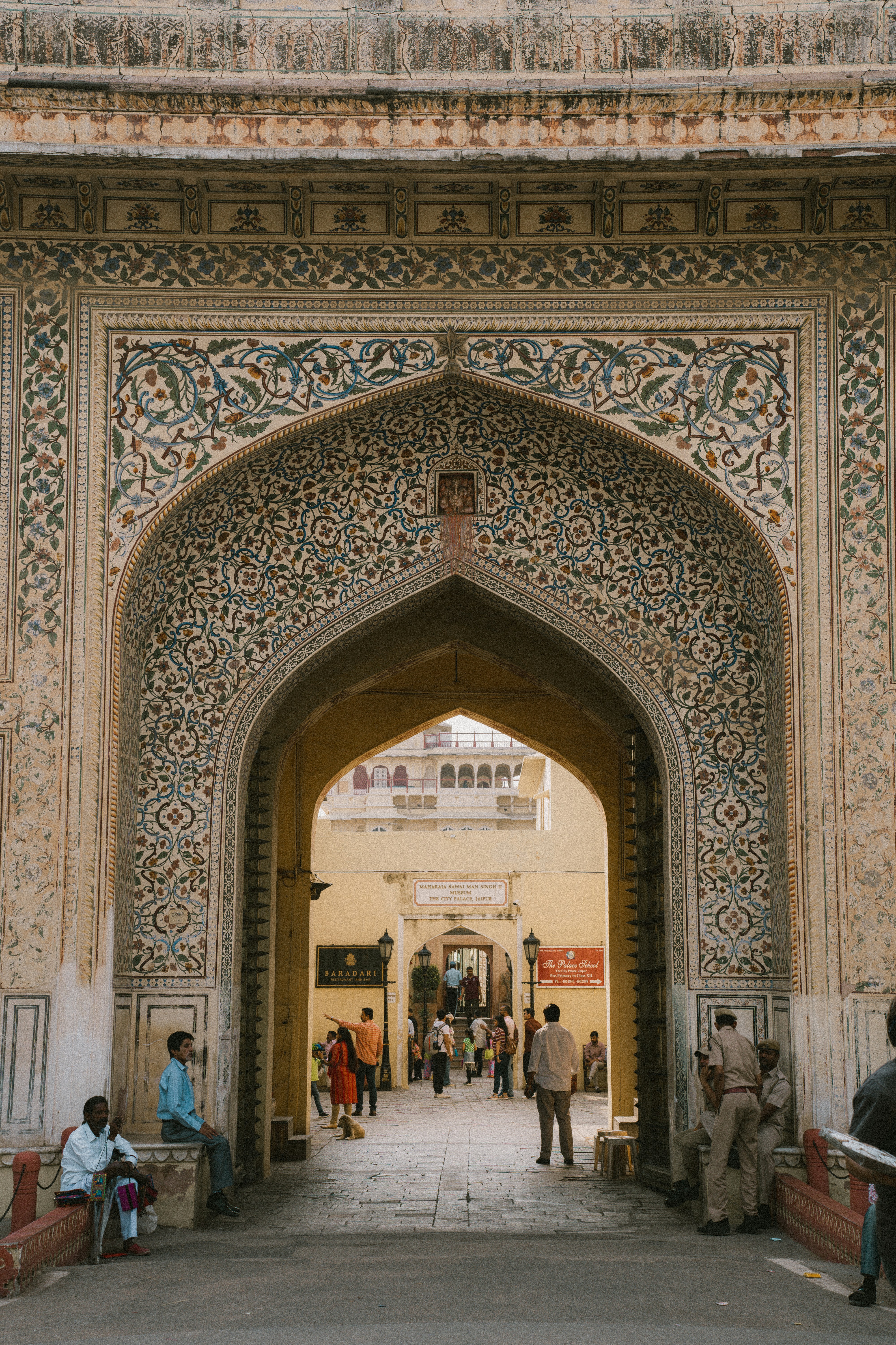 Archway of Colored Tiles Opening to a Courtyard Path