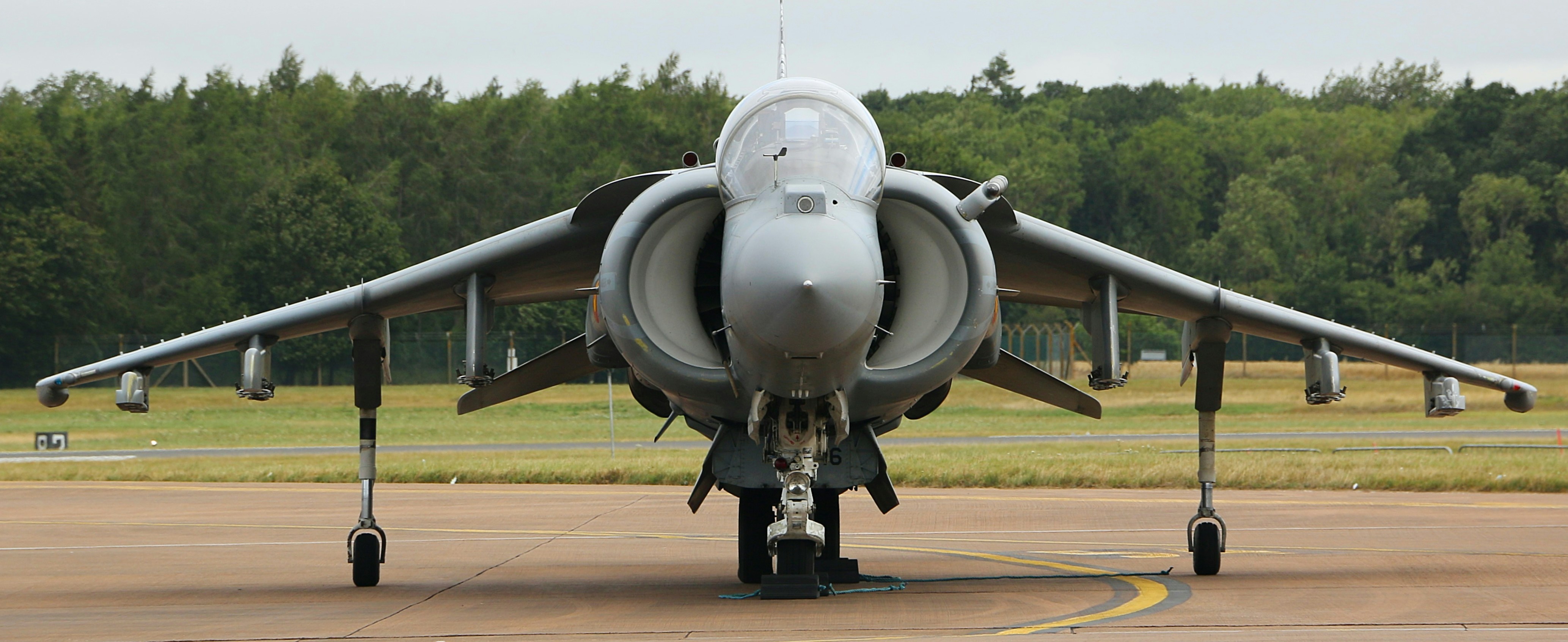 A fighter jet sitting on top of an airport tarmac photo – Free Jet ...