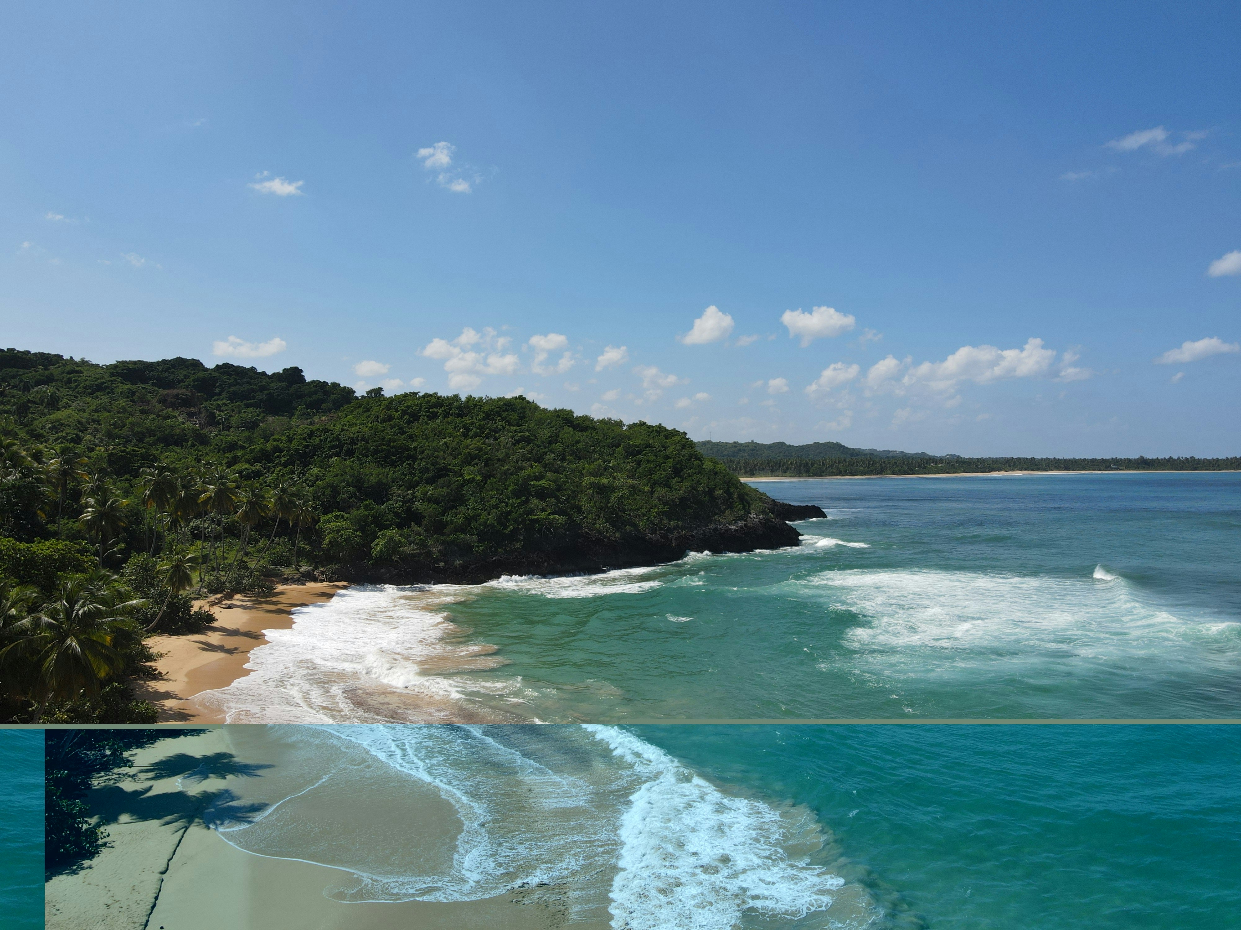 Pristine beach with turquoise waves gently lapping against a lush, forested coastline under a bright blue sky.