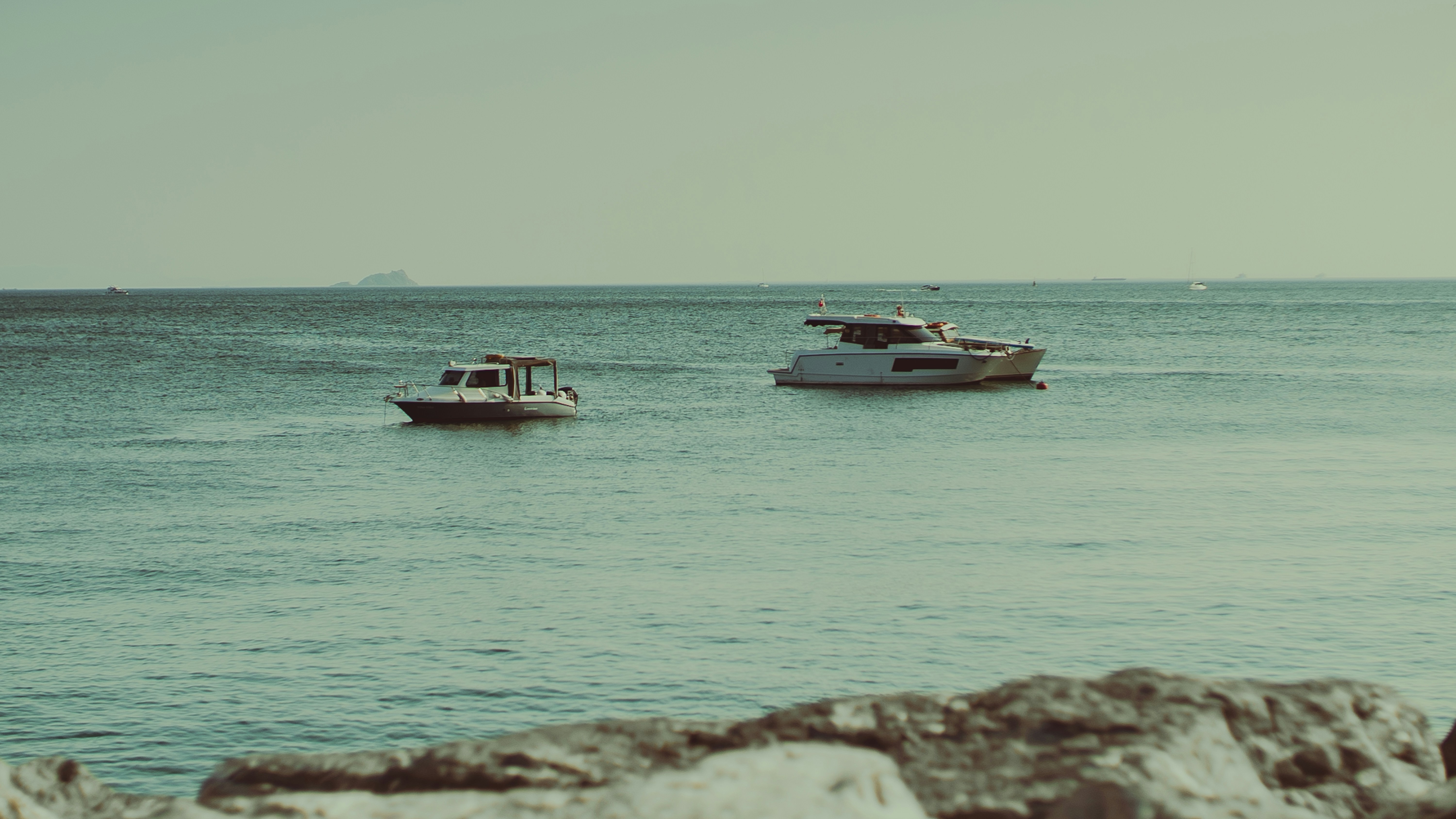 Hushed Currents: A Pair of Boats Hover Between Sea and Sky