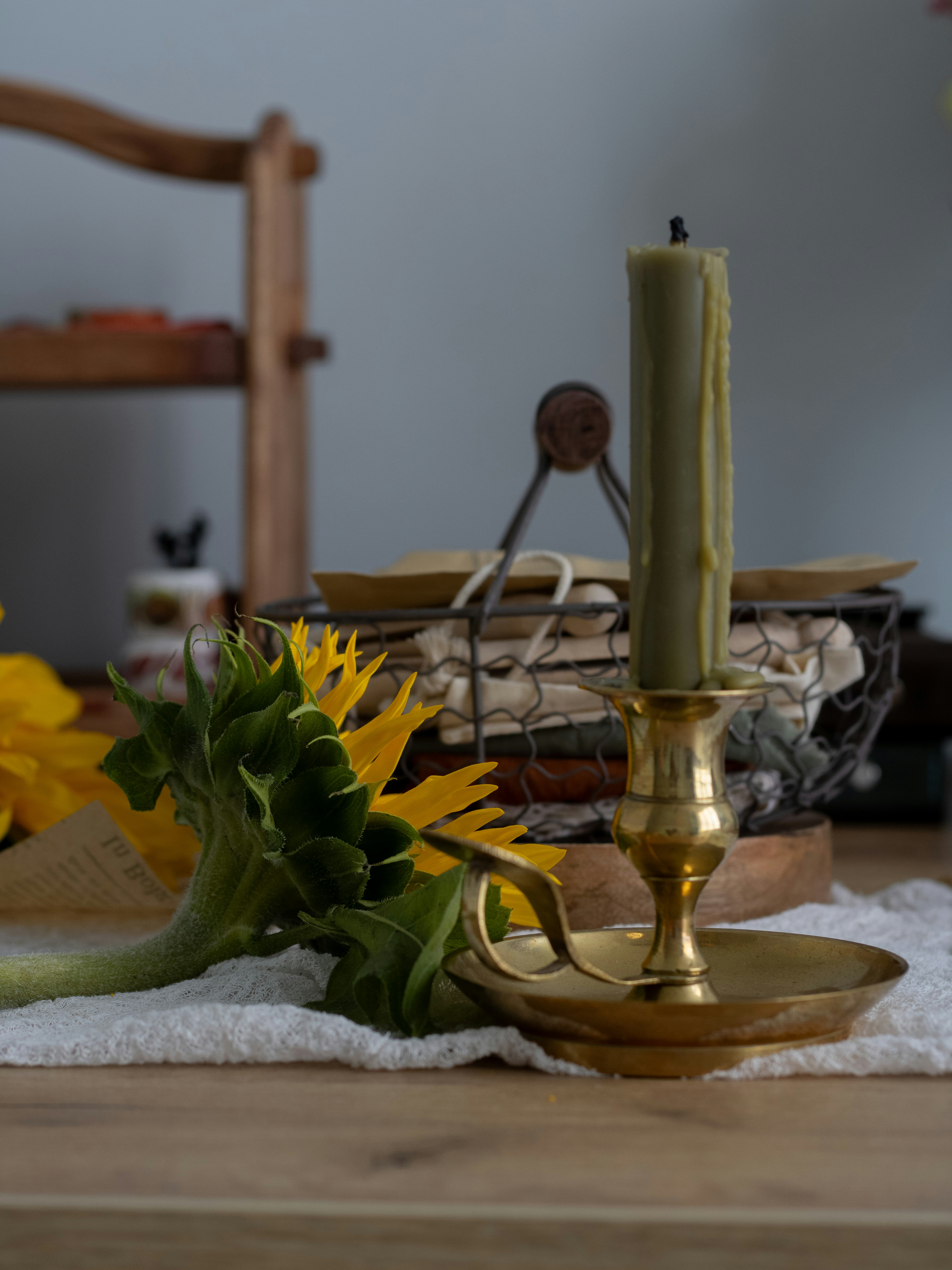 Brass Candlelight Over Sunflowers: A Quiet Still Life