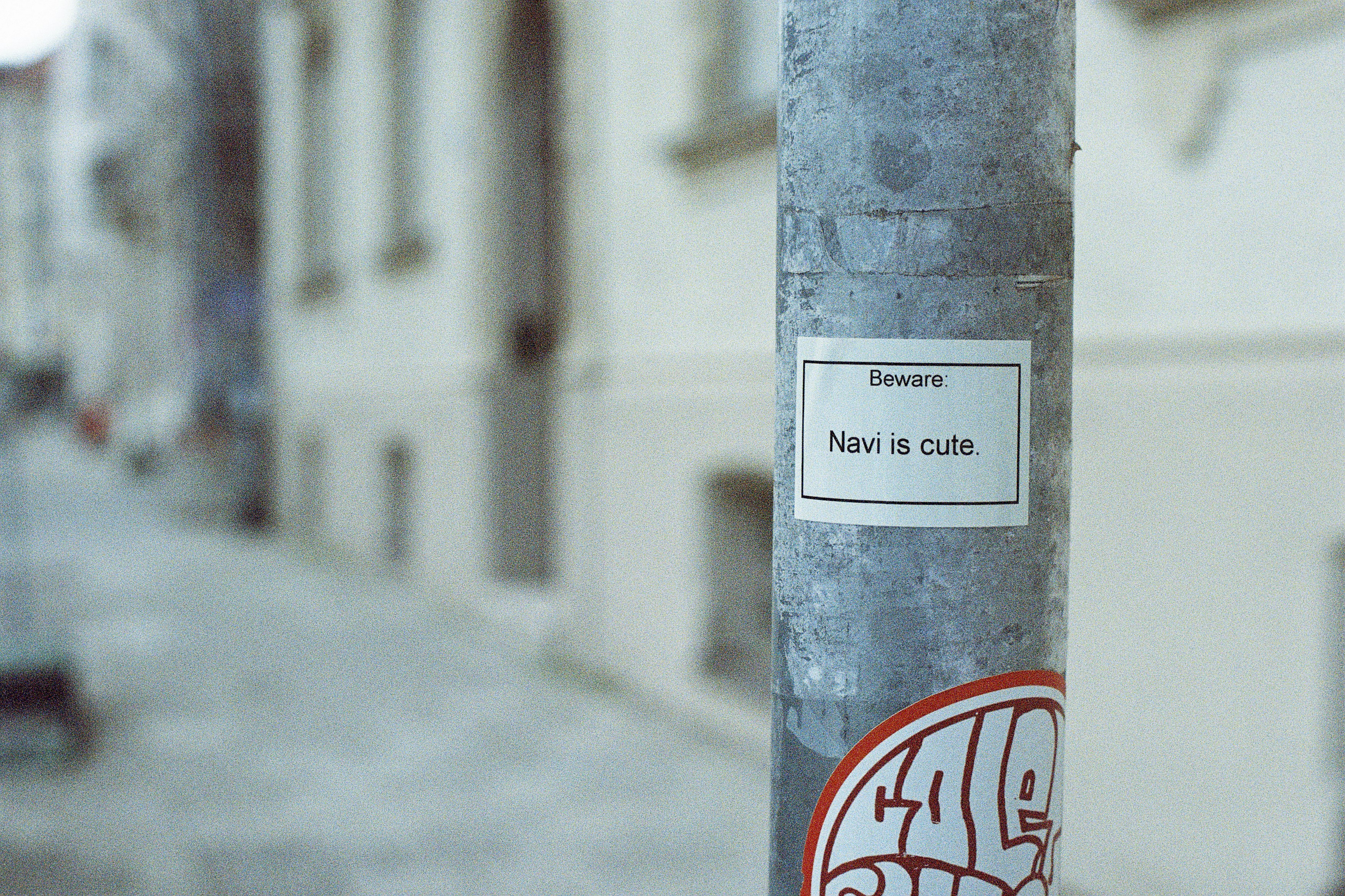A sticker on a pole on a city street photo – Free Germany Image on Unsplash