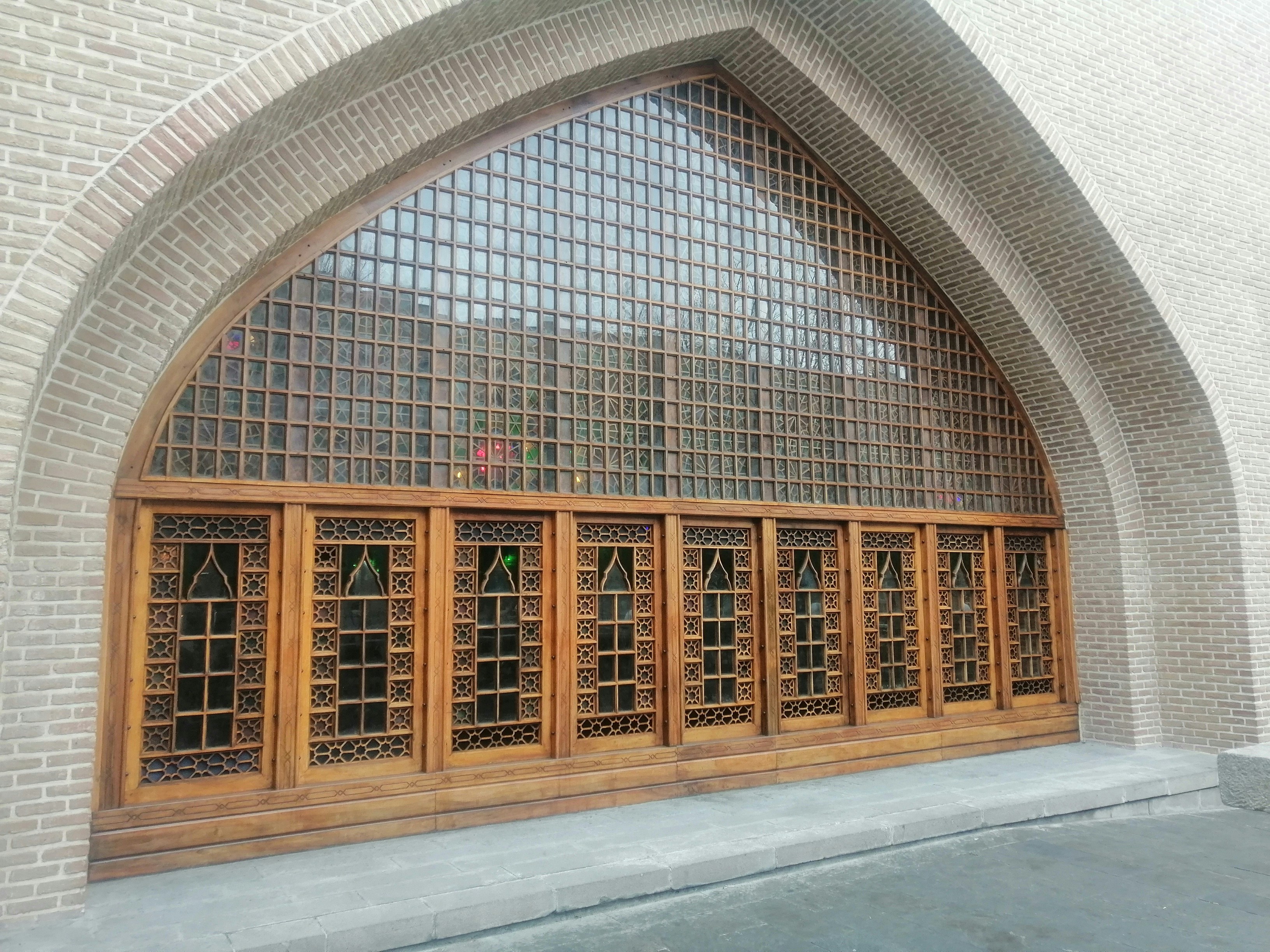 A large wooden window sitting inside of a building photo – Free Iran ...