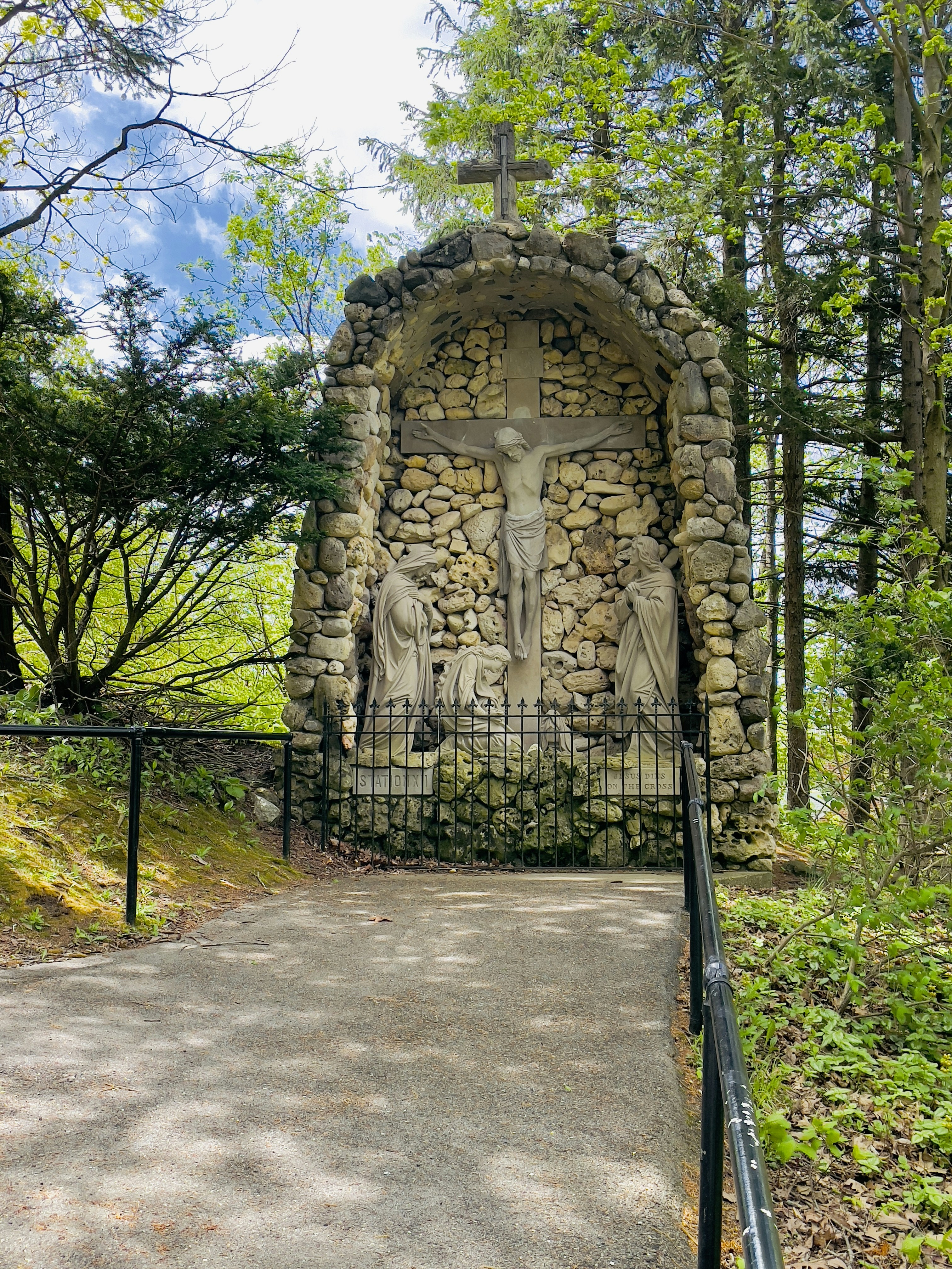 A statue of a crucifix on a stone wall photo – Free Jesus christ Image ...