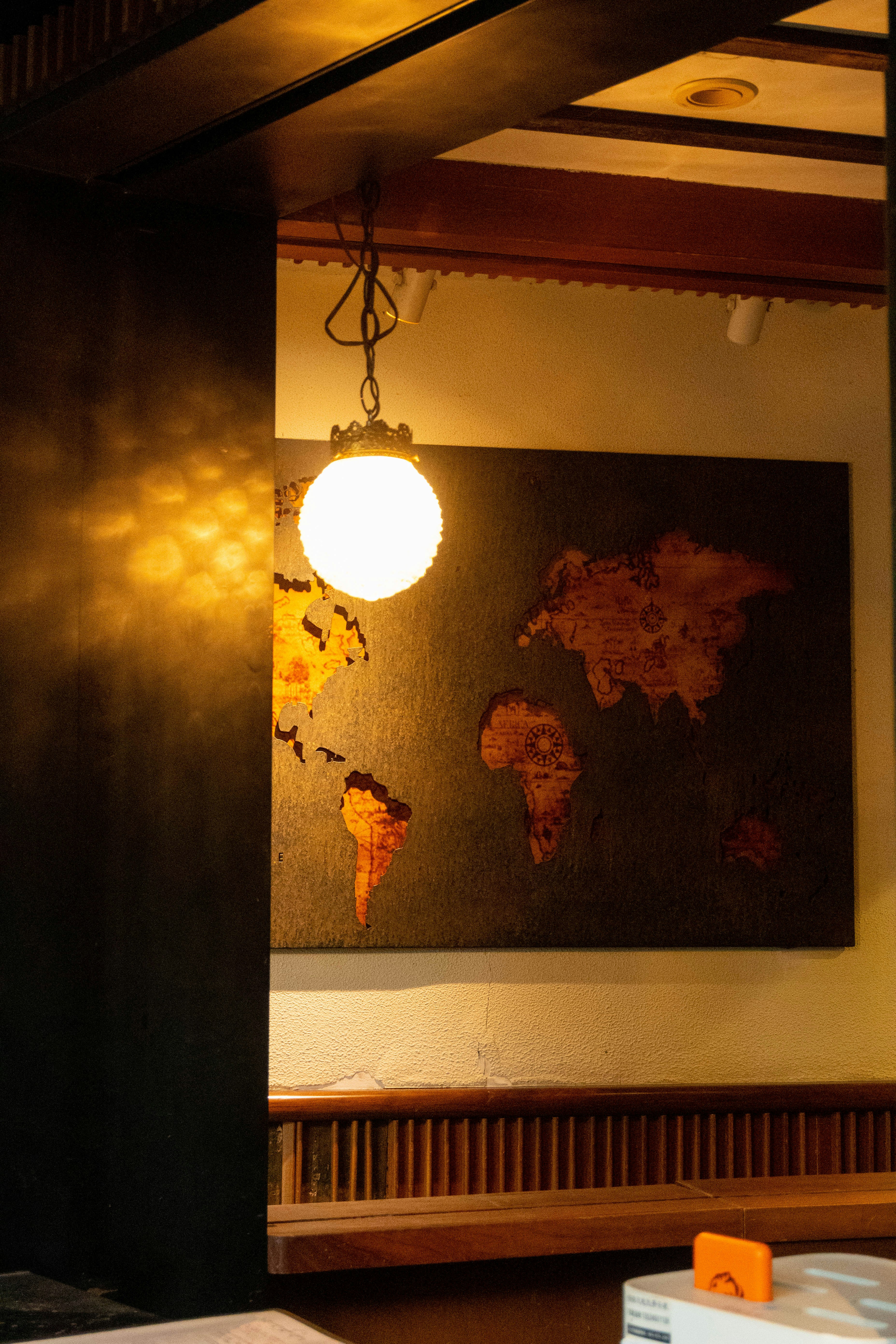 A picture of a world map hanging on a wall photo – Free Lighting Image ...