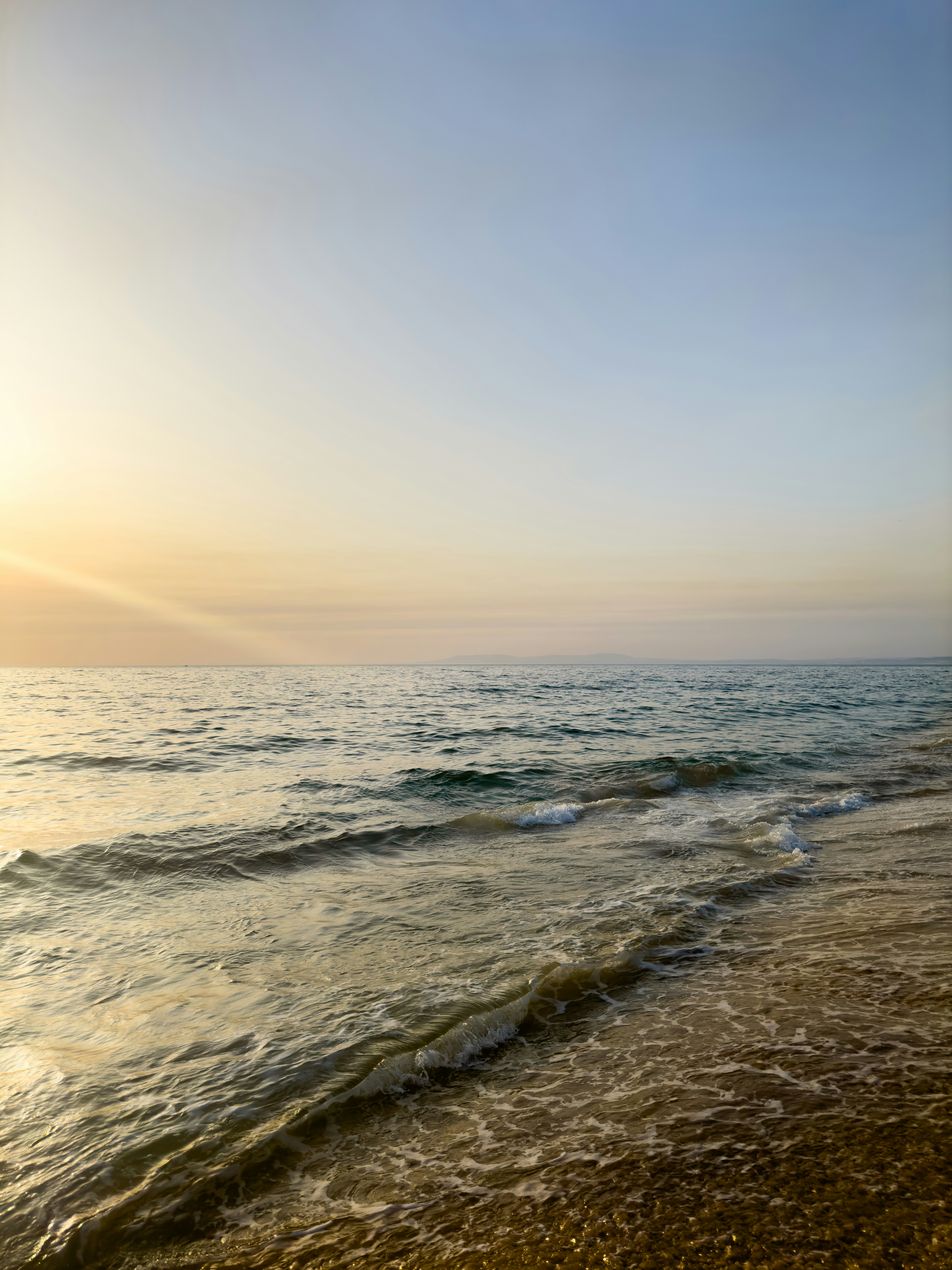 The sun is setting over the water at the beach photo – Free Nature ...