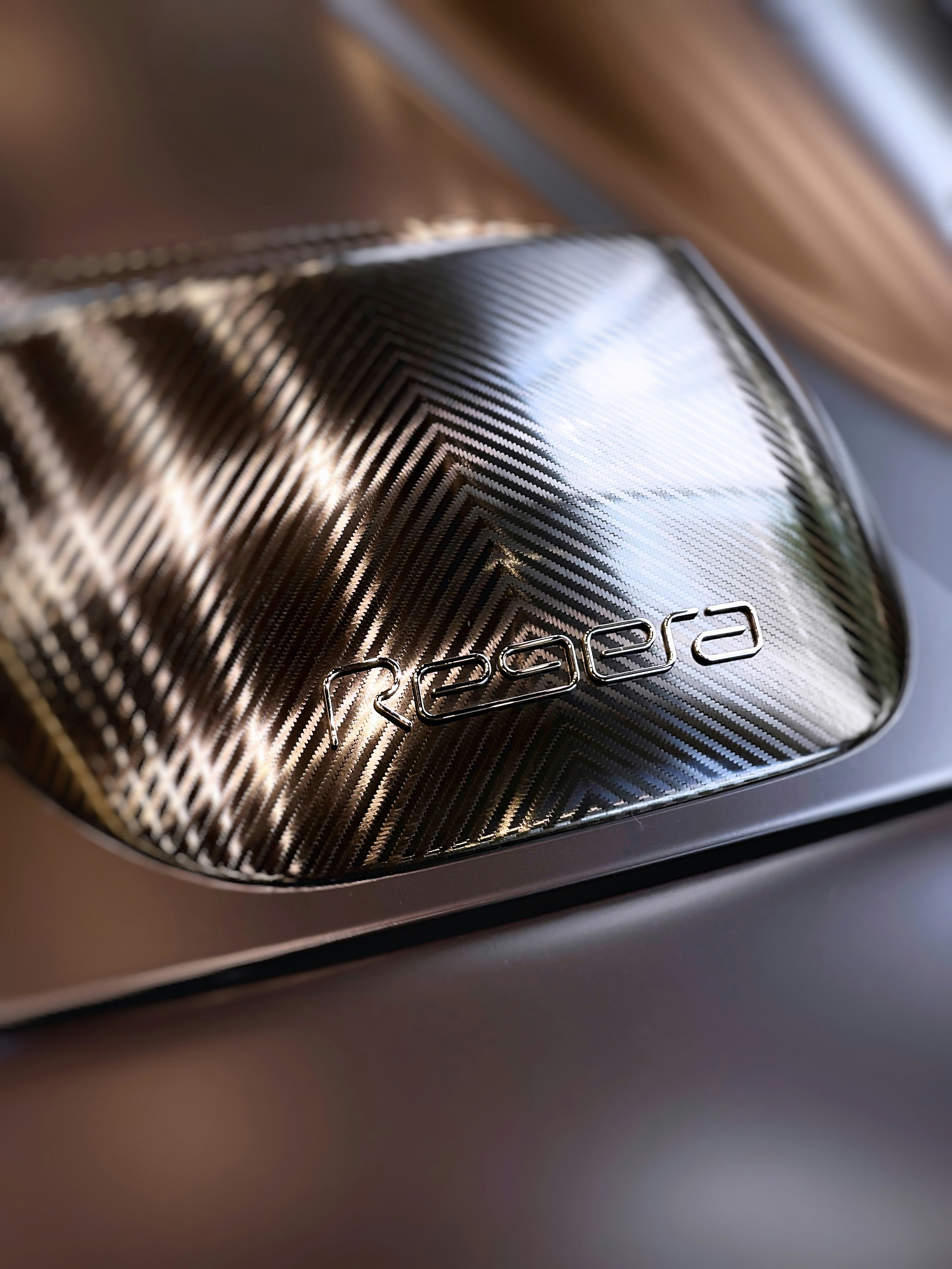 Koenigsegg Agera badge in carbon-fiber weave: a macro close-up