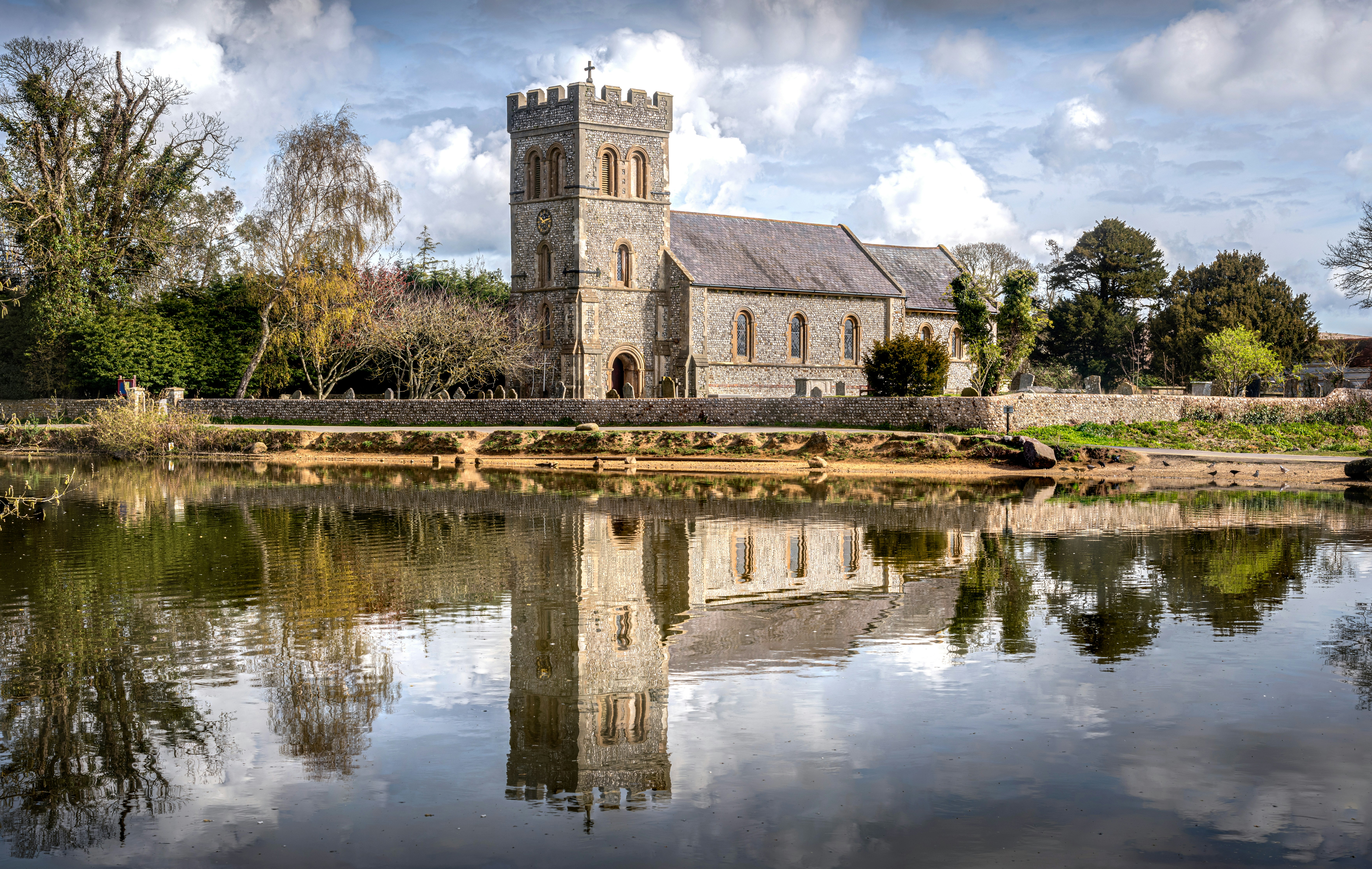A large building sitting next to a body of water photo – Free Falmer ...