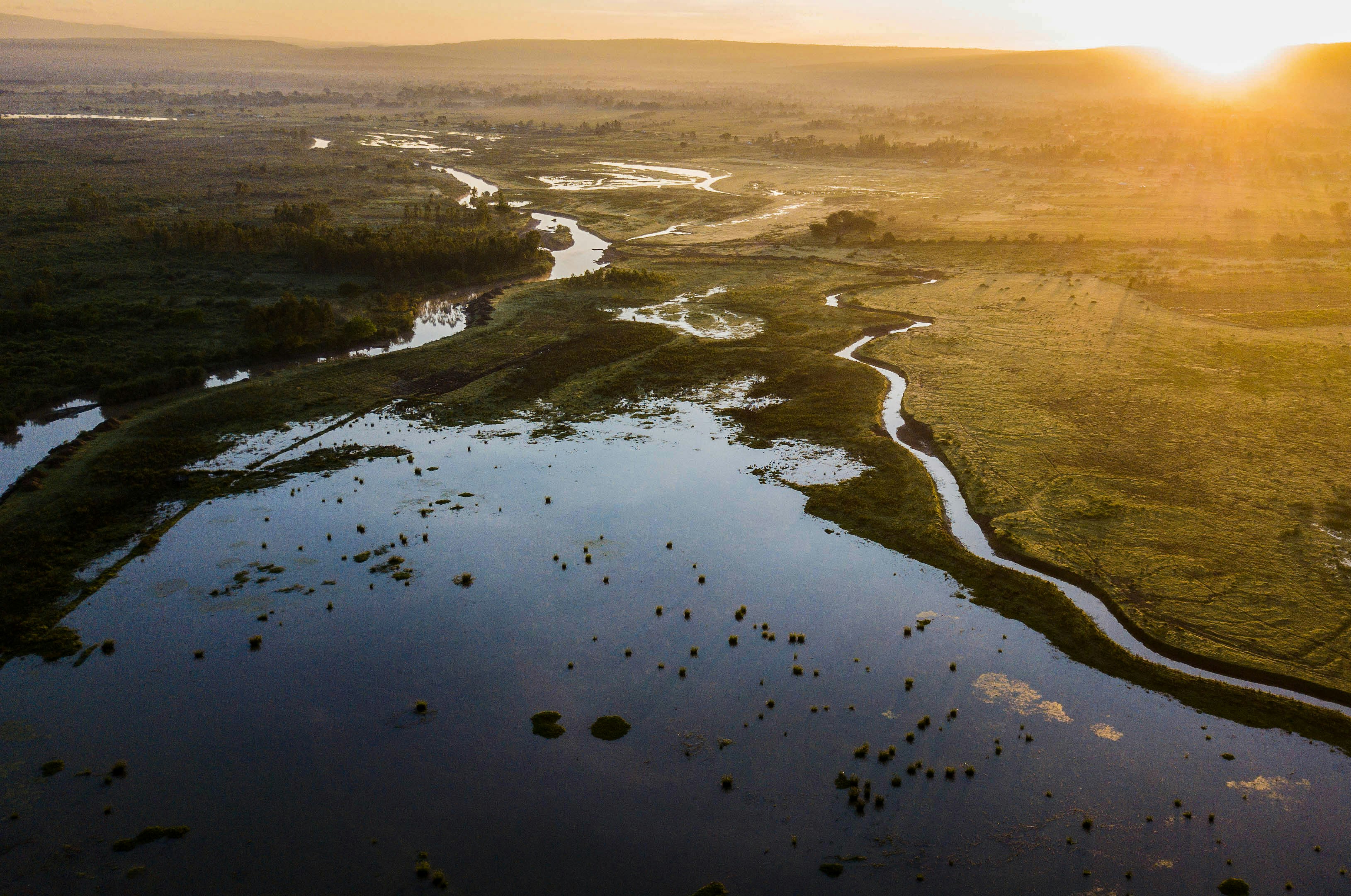 A river running through a lush green countryside photo – Free Nyando ...