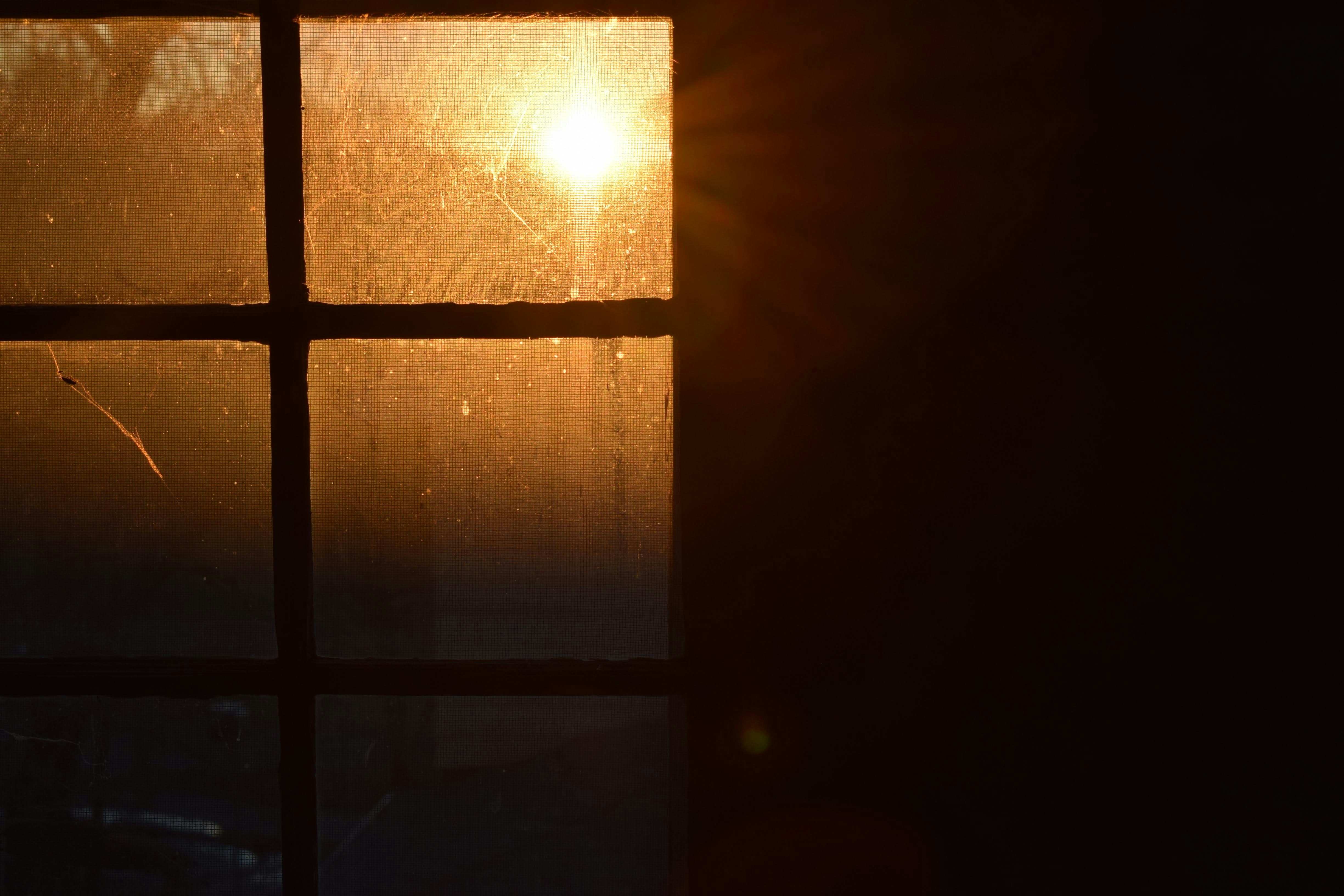 The sun is shining through a window in a dark room photo – Free Flare ...