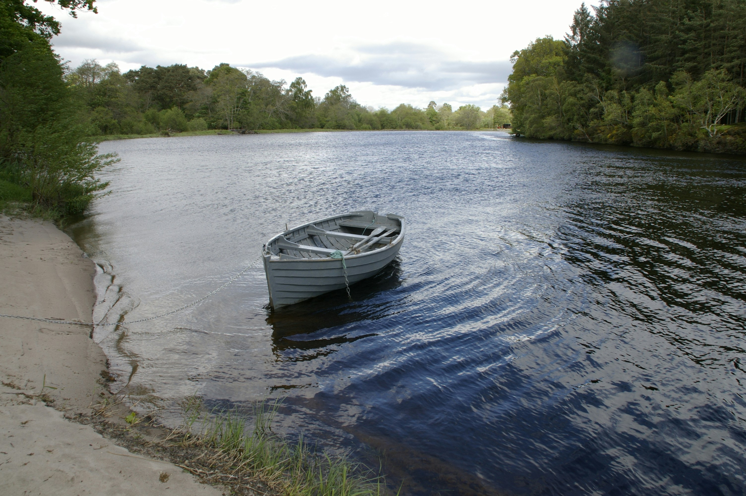 Lone Rowboat at the River's Quiet Bend