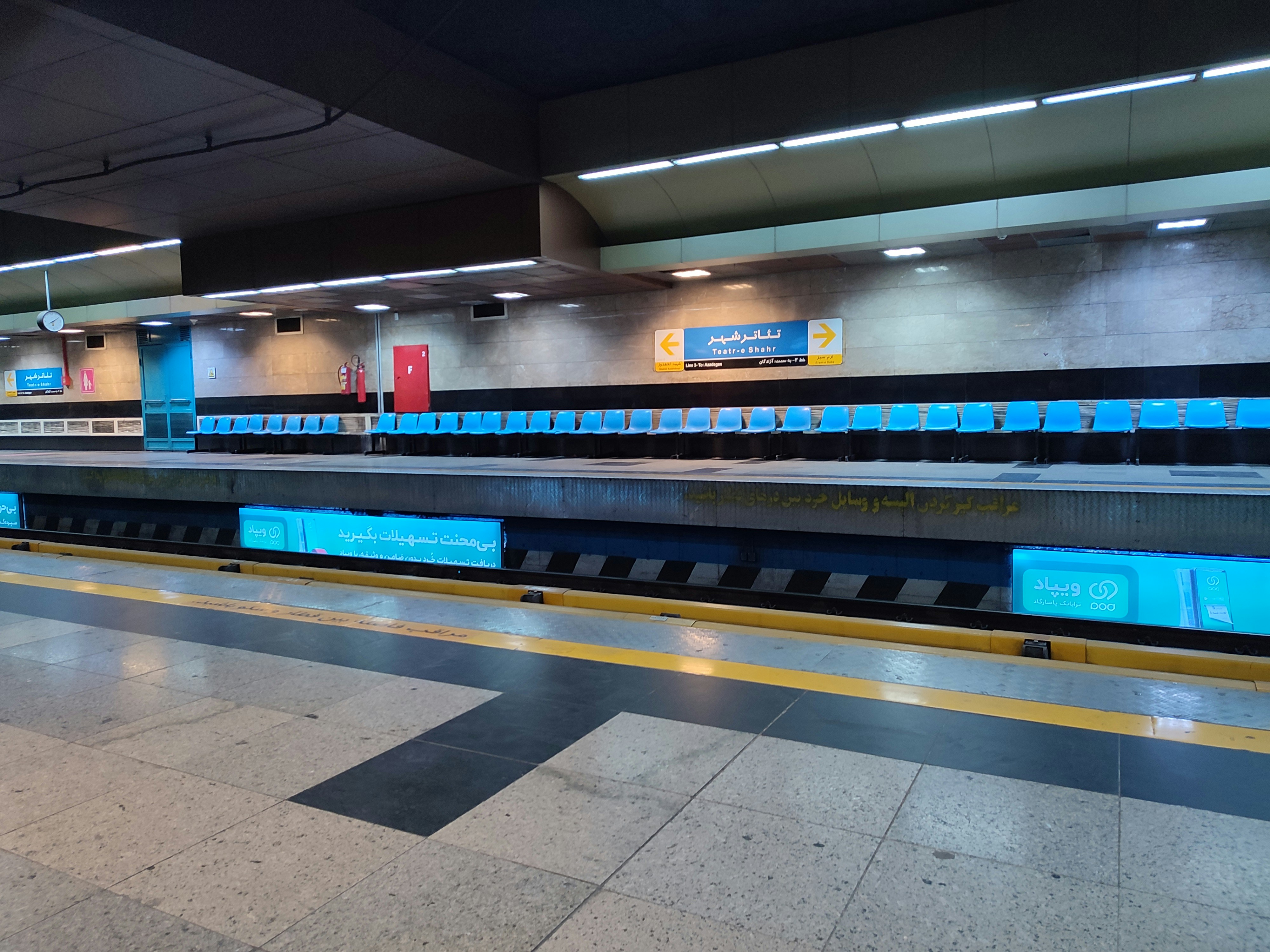 Blue Row at the Metro: Geometry of Light on a Quiet Platform