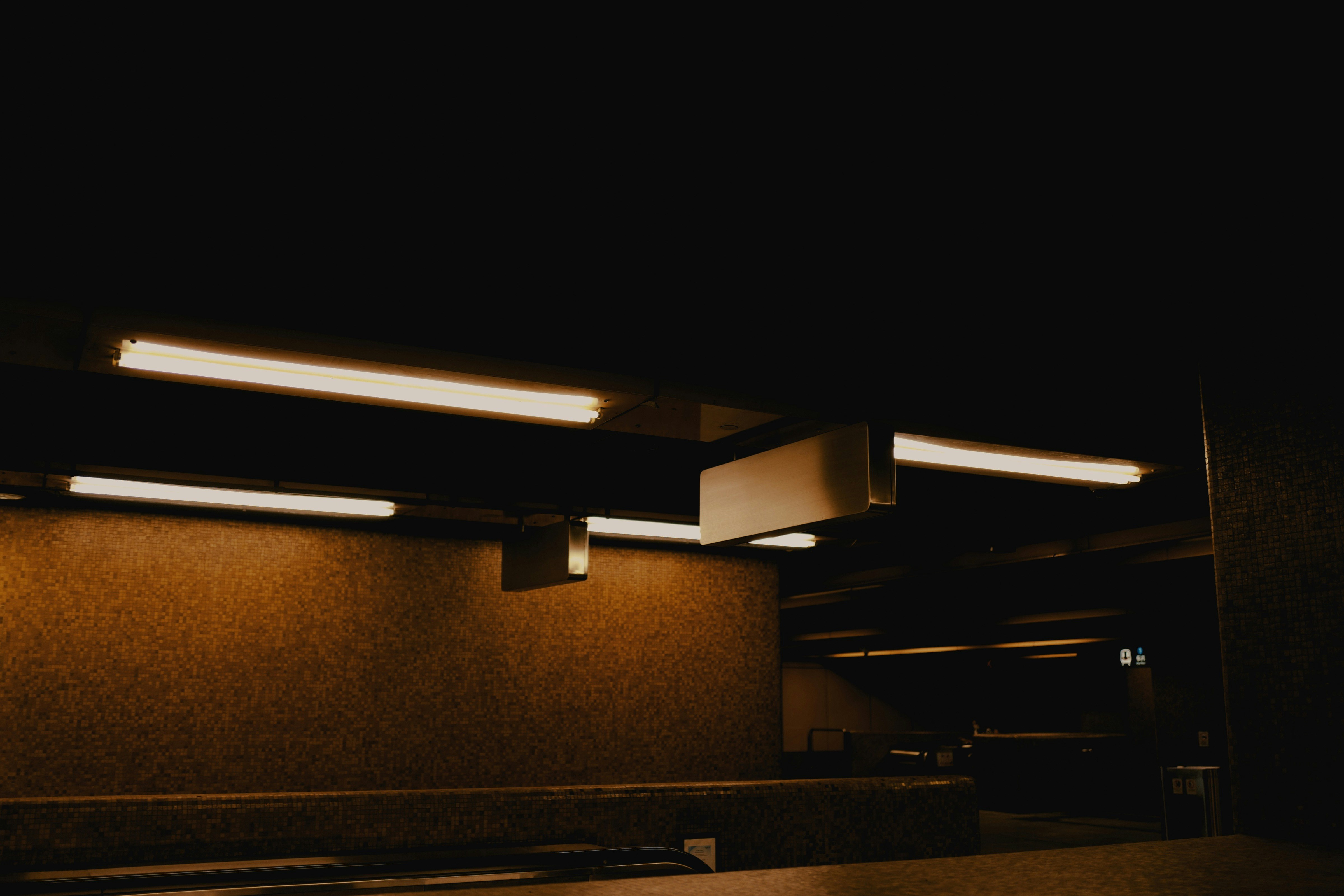 A dimly lit room with benches and lights photo – Free Lighting Image on ...