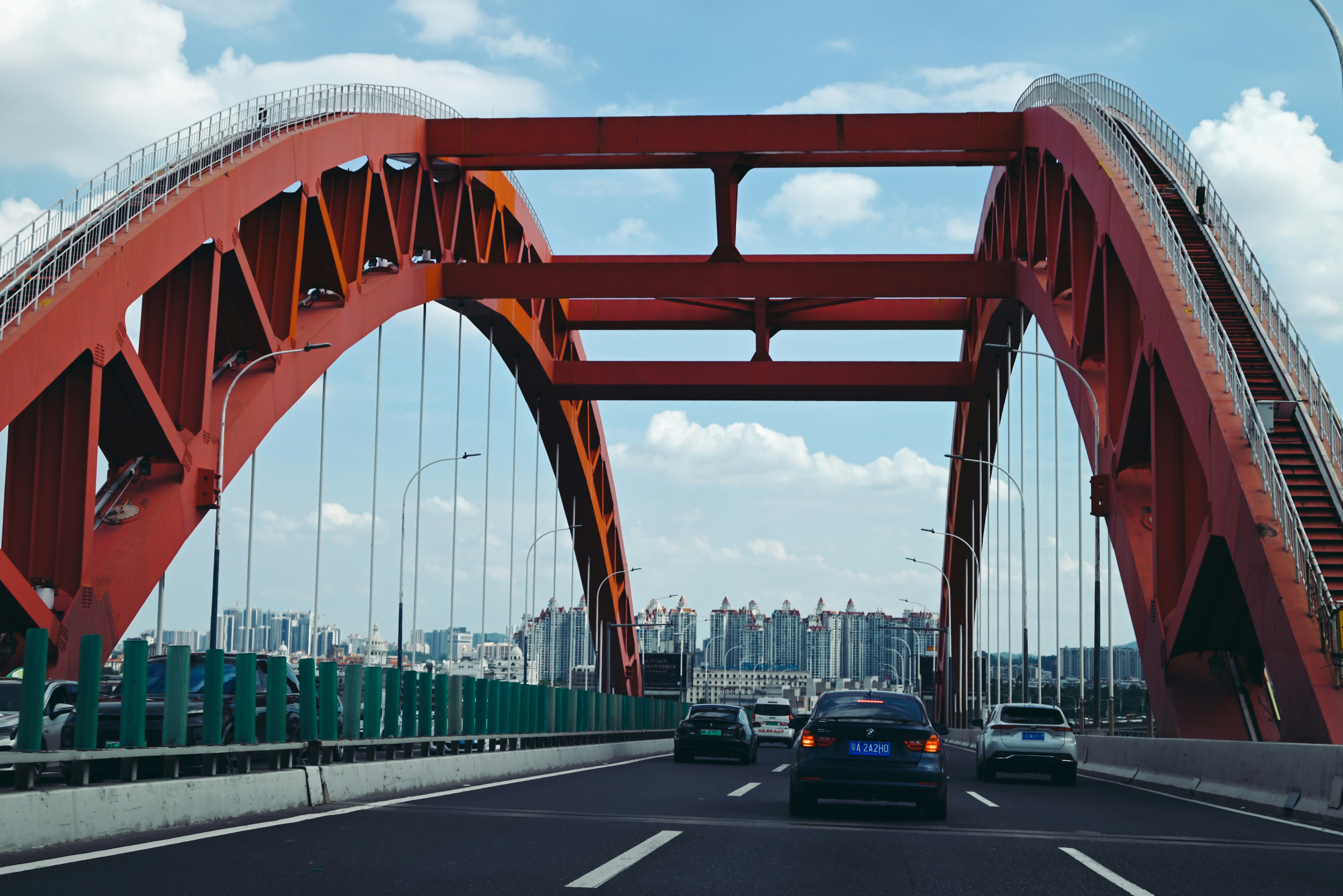 A red bridge with cars going over it photo – Free Arch Image on Unsplash