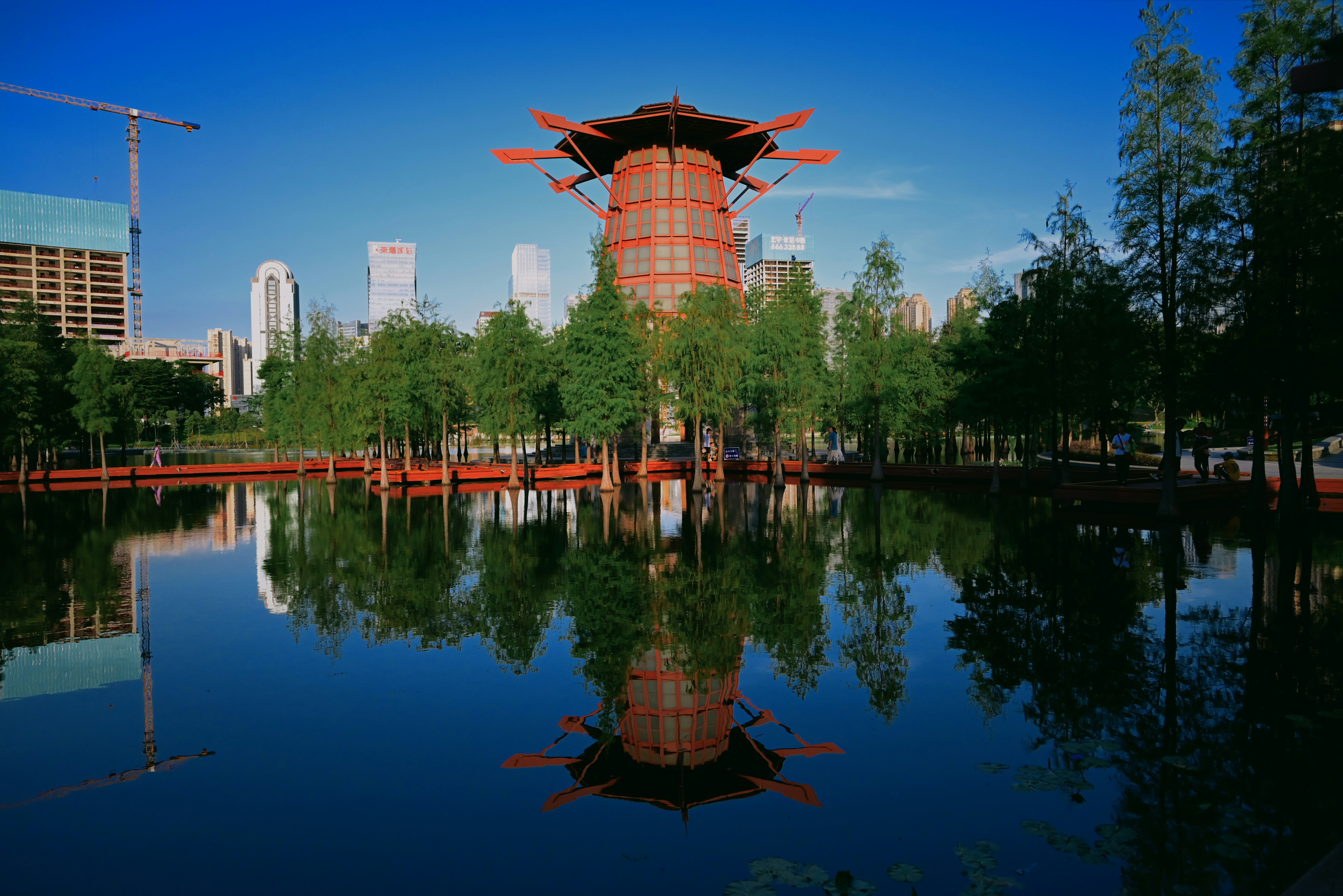 A large red tower sitting above a body of water photo – Free Outdoors ...