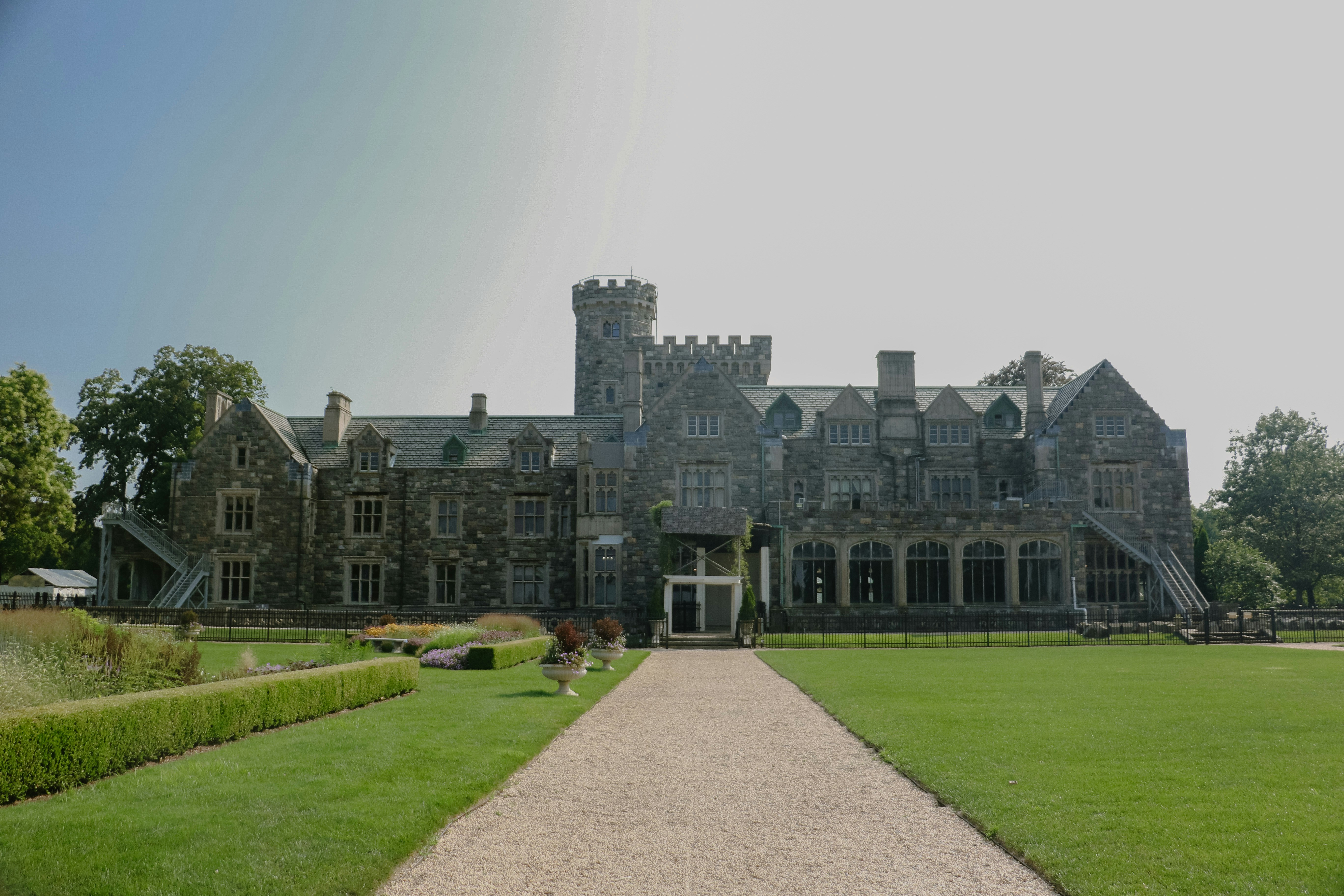 A large stone building with a walkway leading to it photo – Free ...