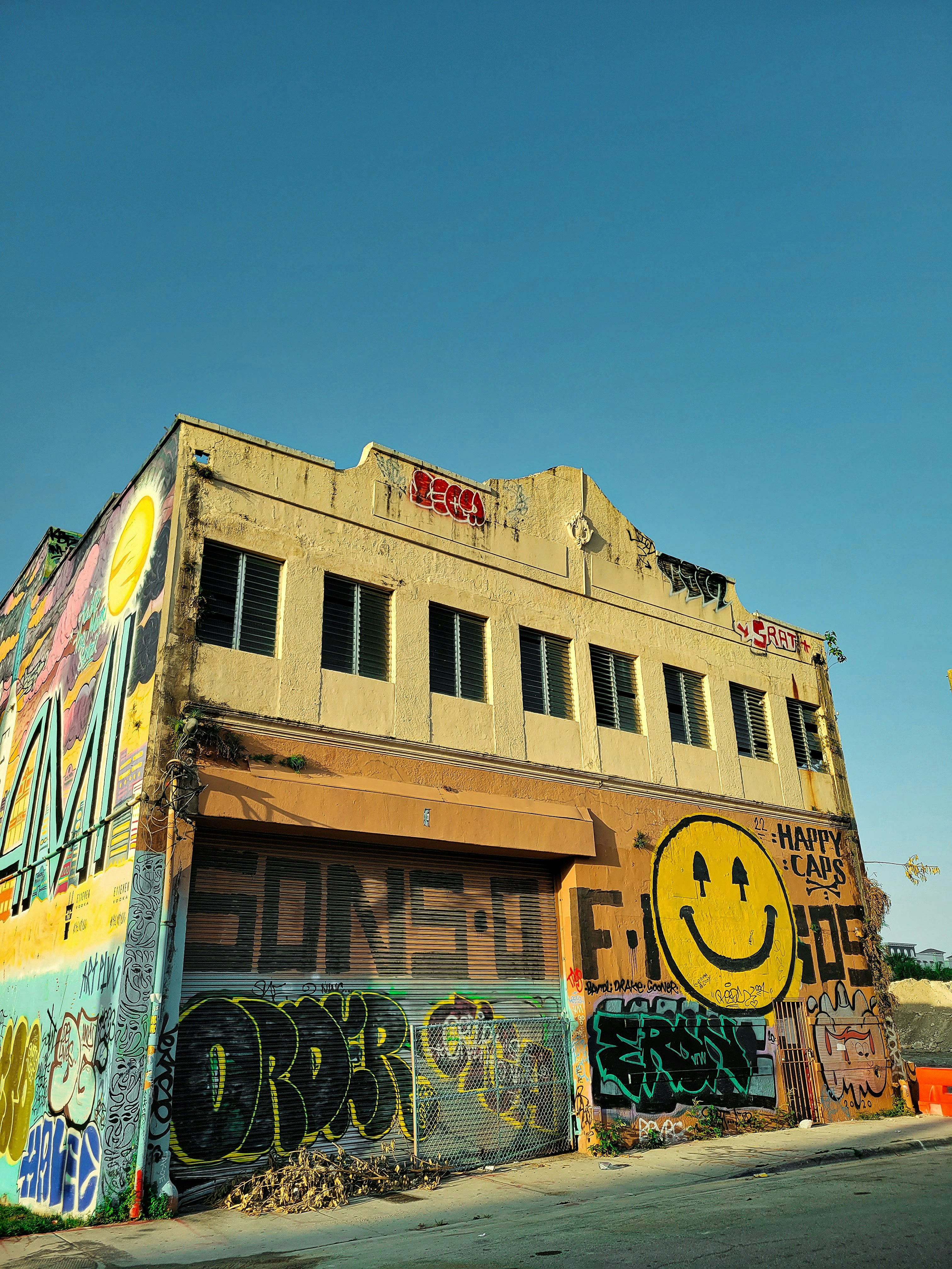 A building with a smiley face painted on it photo – Free Building Image ...