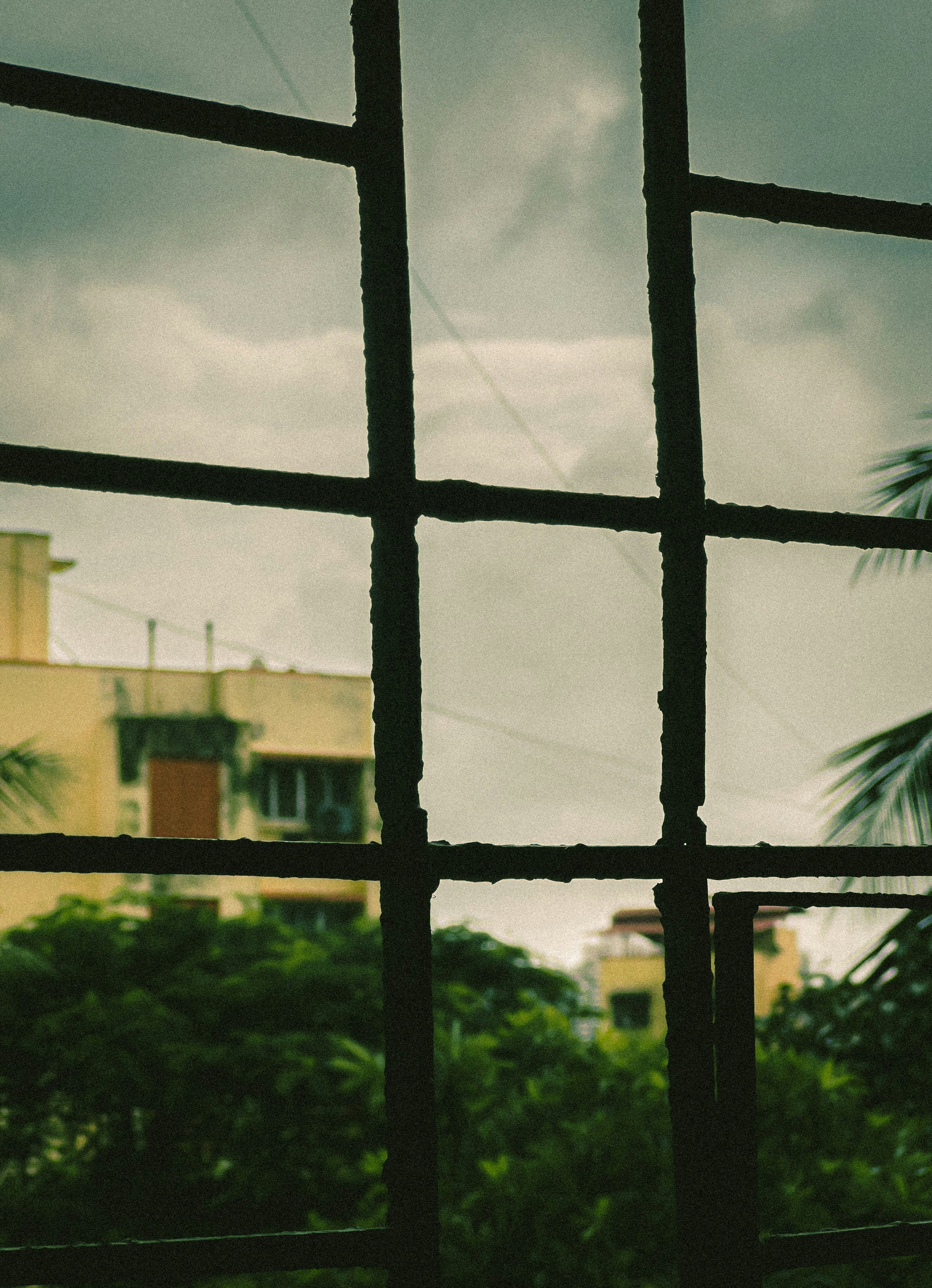 A view of a building through a window photo – Free Cross Image on Unsplash