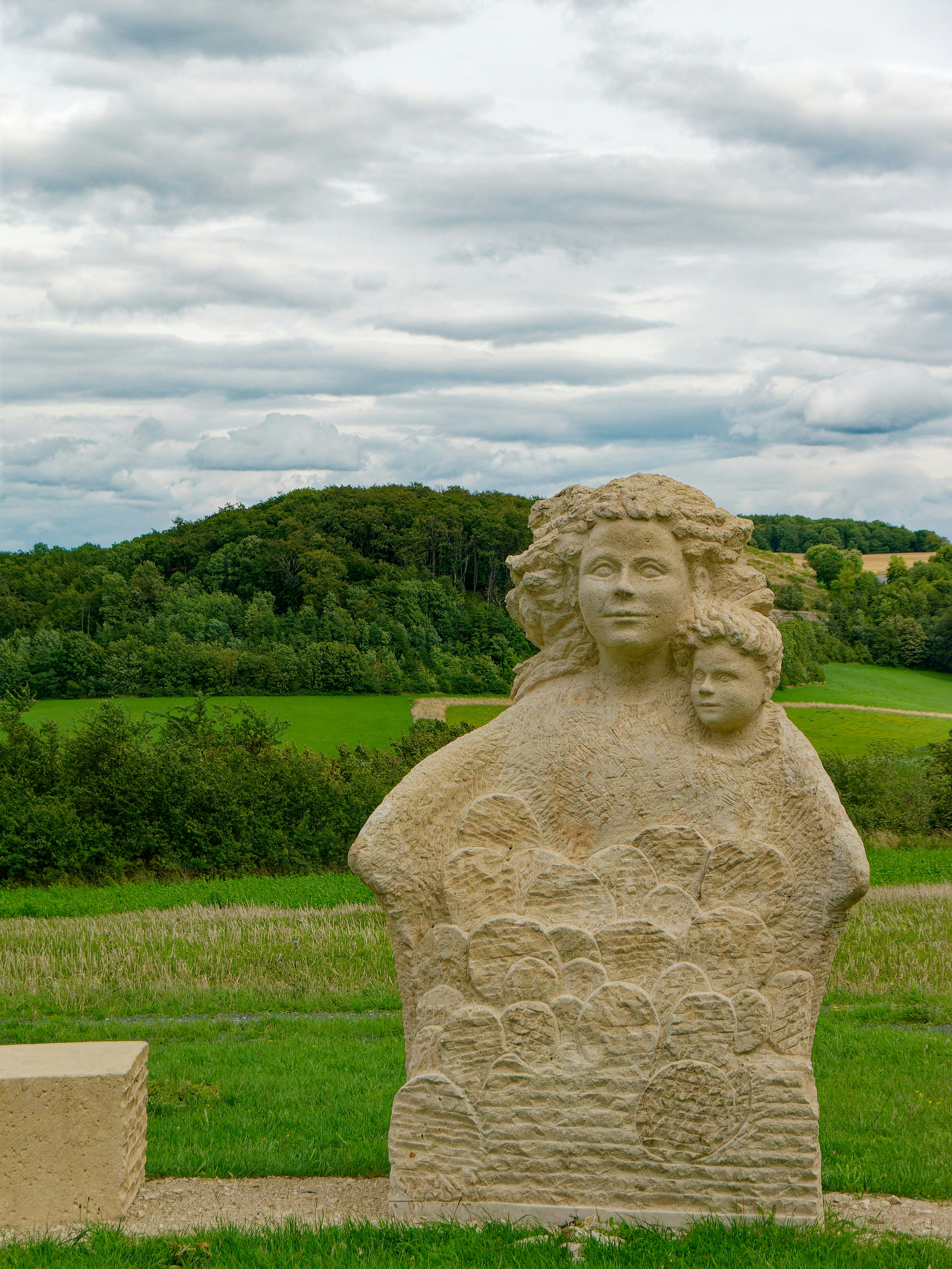 Stone Embrace: Mother and Child Relief in a Field
