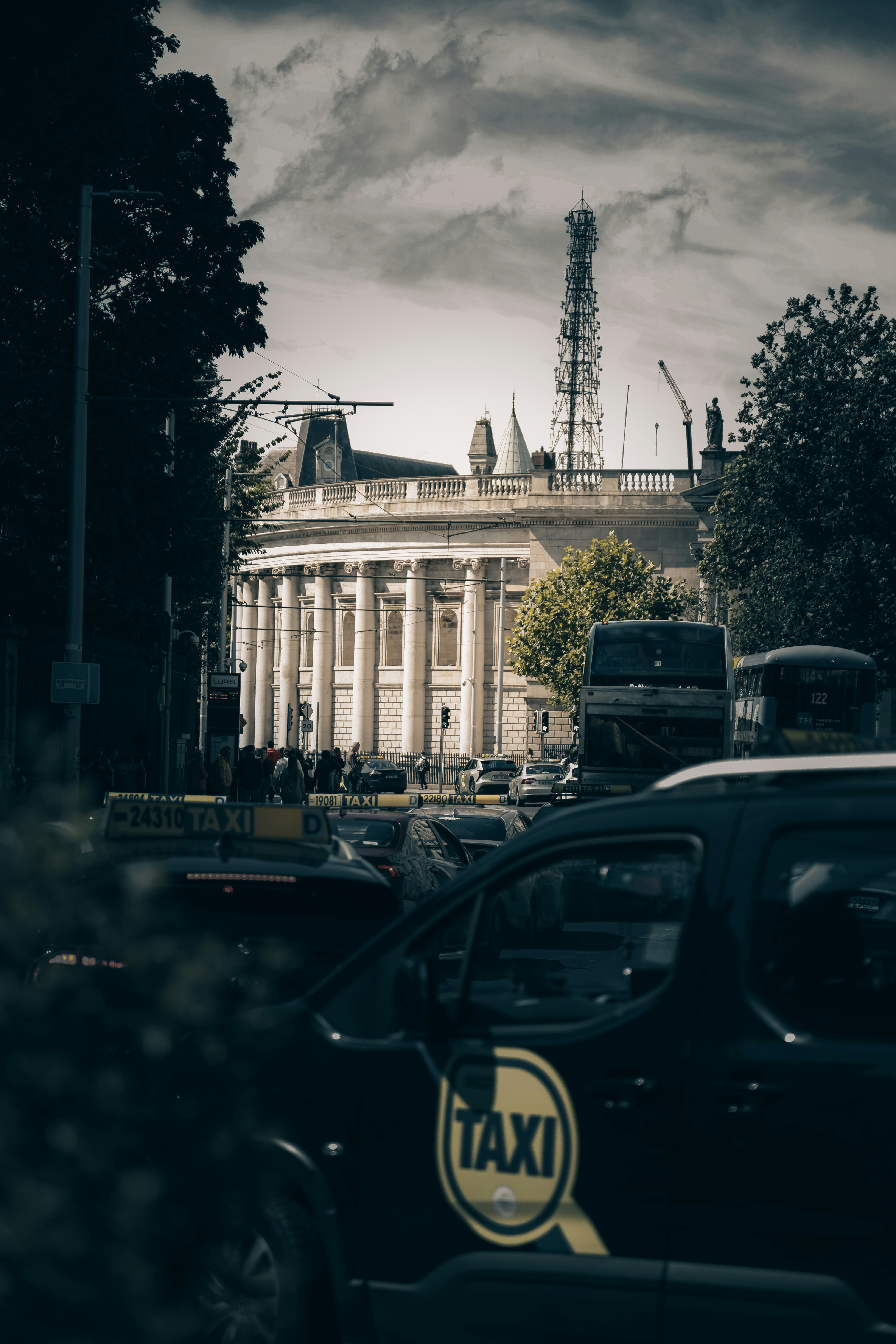 City Taxi Constellation: A Classical Facade Framed by Traffic