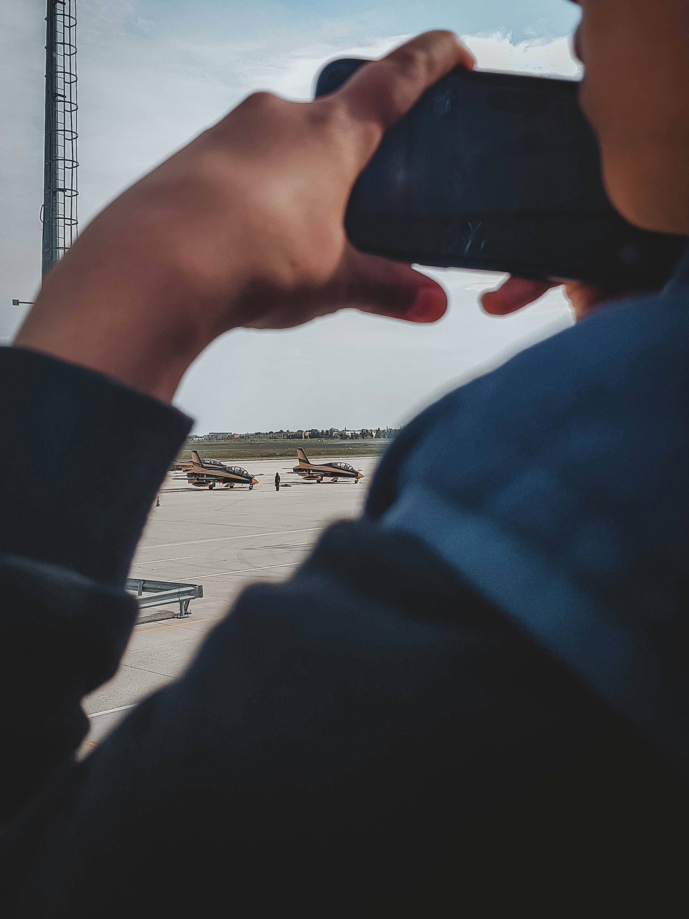 Grainy Backdrop: A Traveler Captures a Quiet Airfield Moment